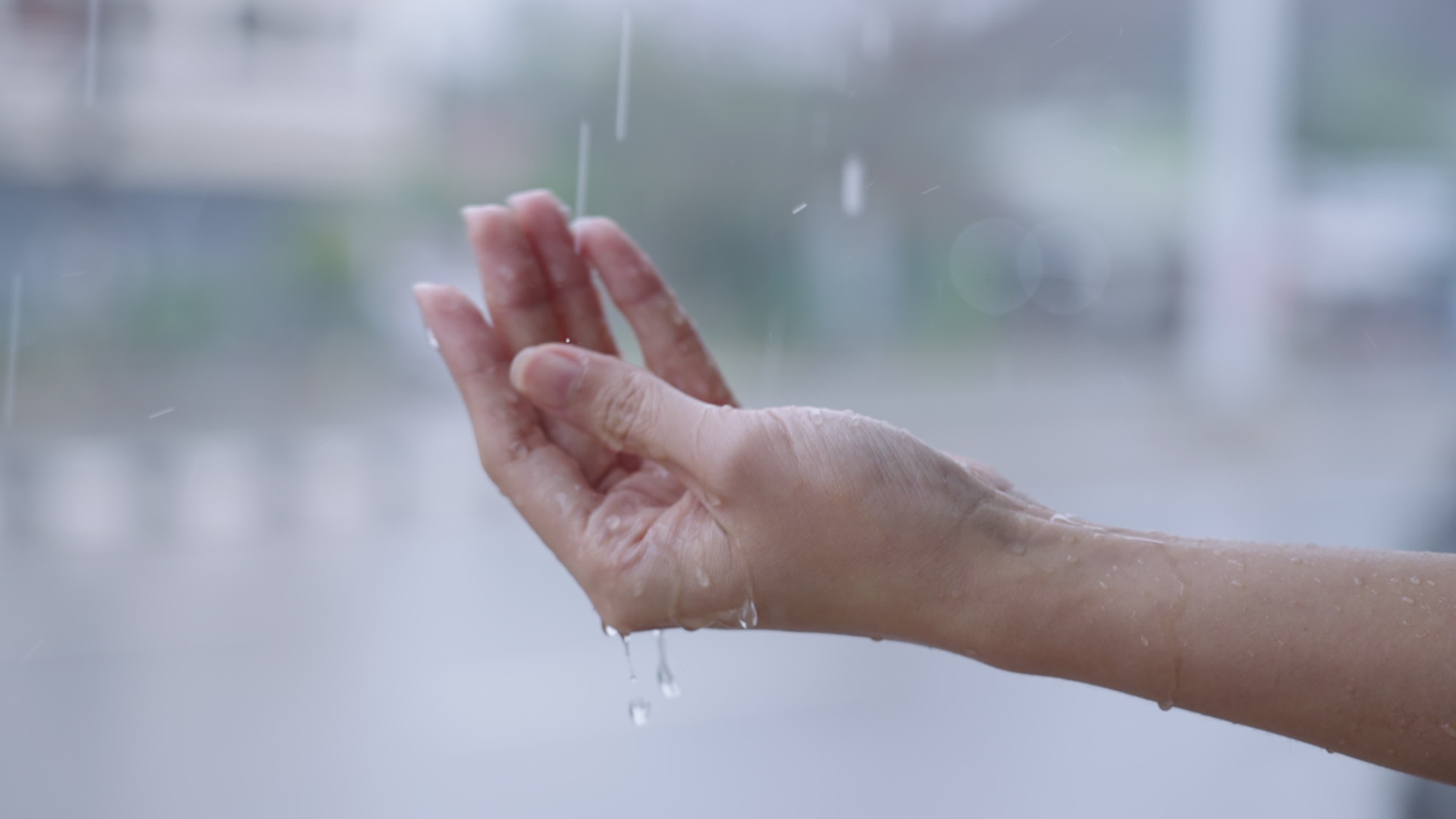 Rain Drops To Female Light Skin Hand Rainy Day With Car Driving Pass