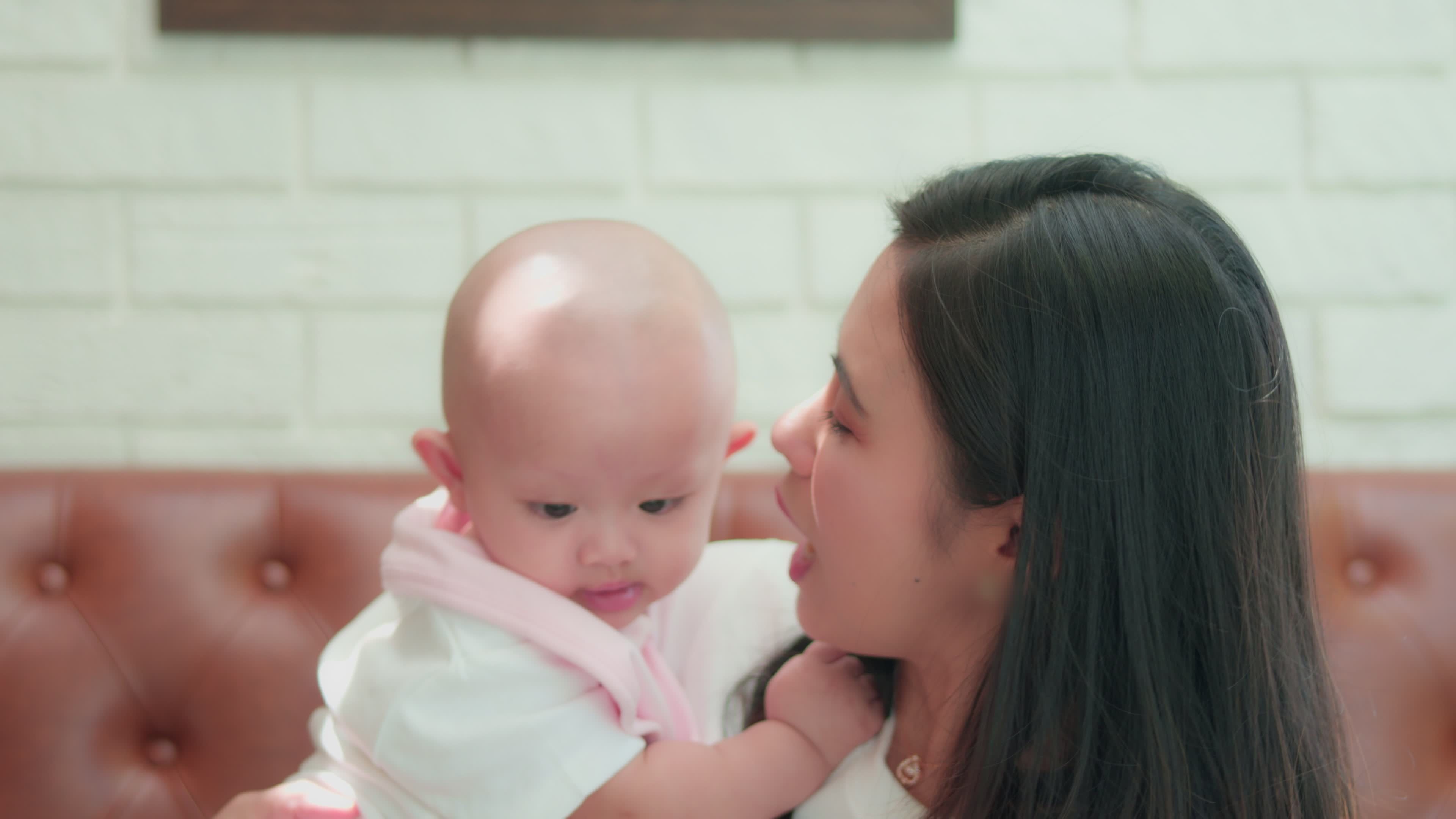 Cute, newborn Asian baby boy. Family happy, Asian young mother is playing, carrying and taking ...