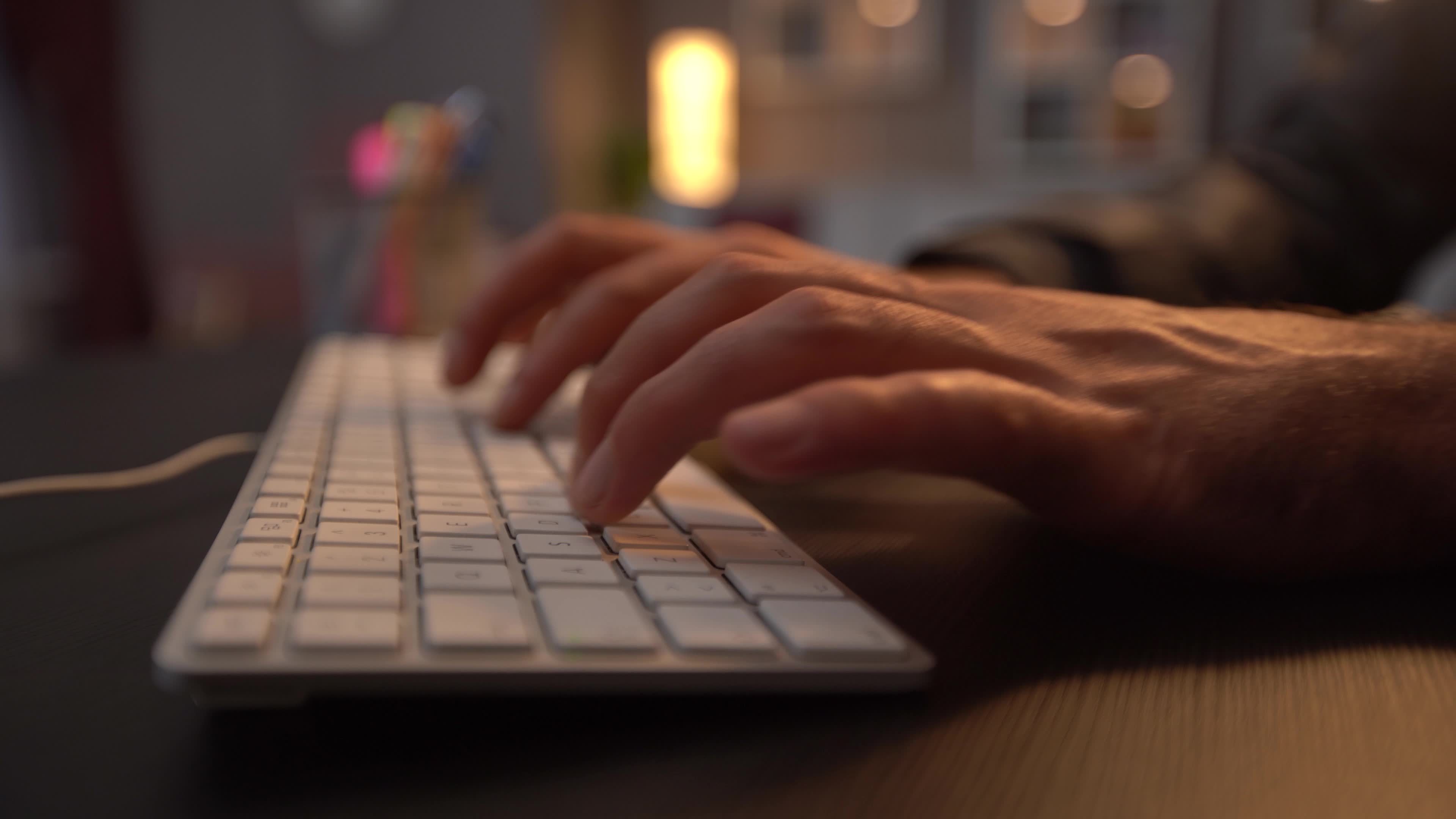 Close-up image of working on keyboard. Evening work. Working on the ...