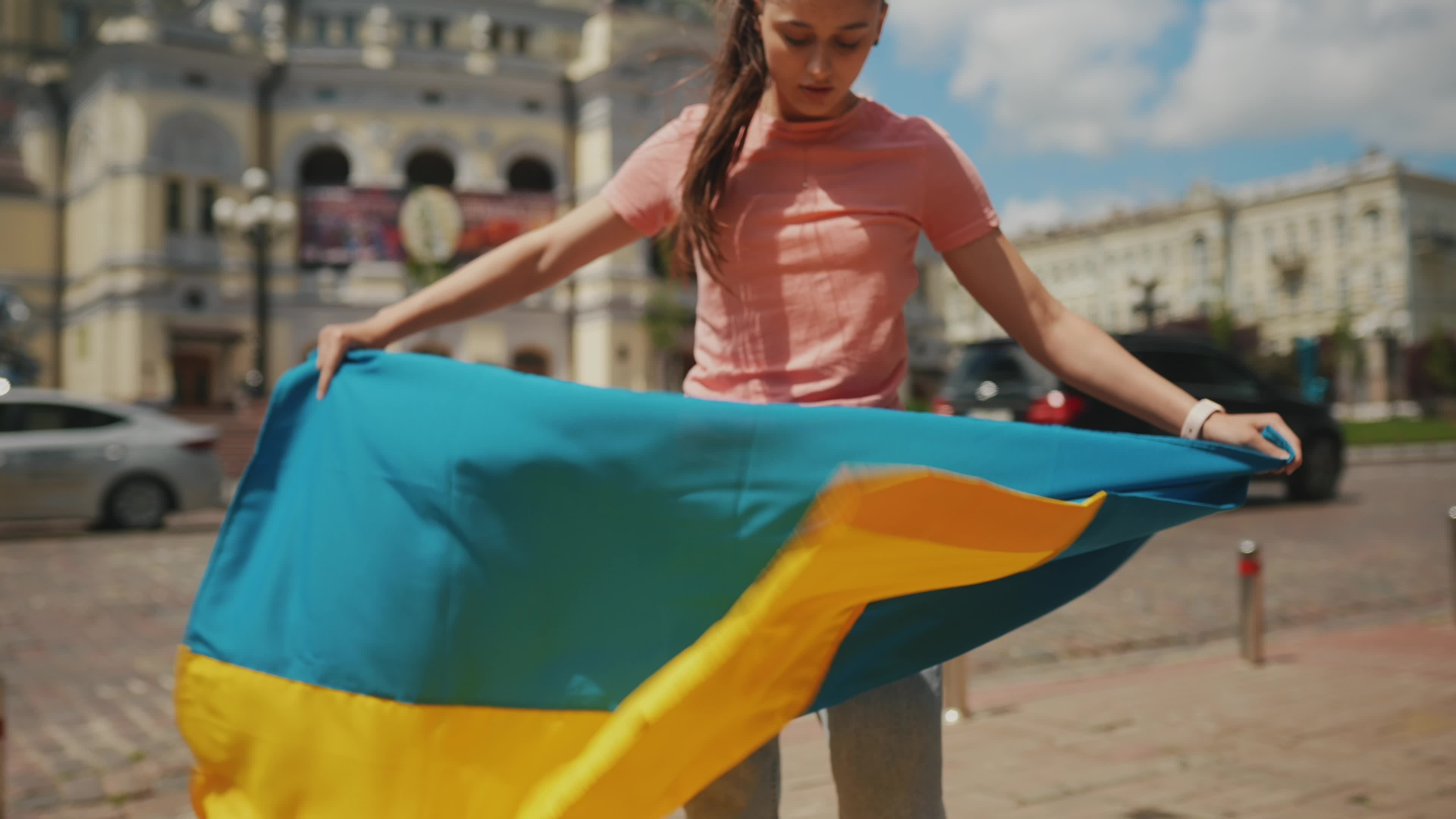 Young woman holds and waves flag of Ukraine in downtown Kyiv 10851028 Stock Video at Vecteezy
