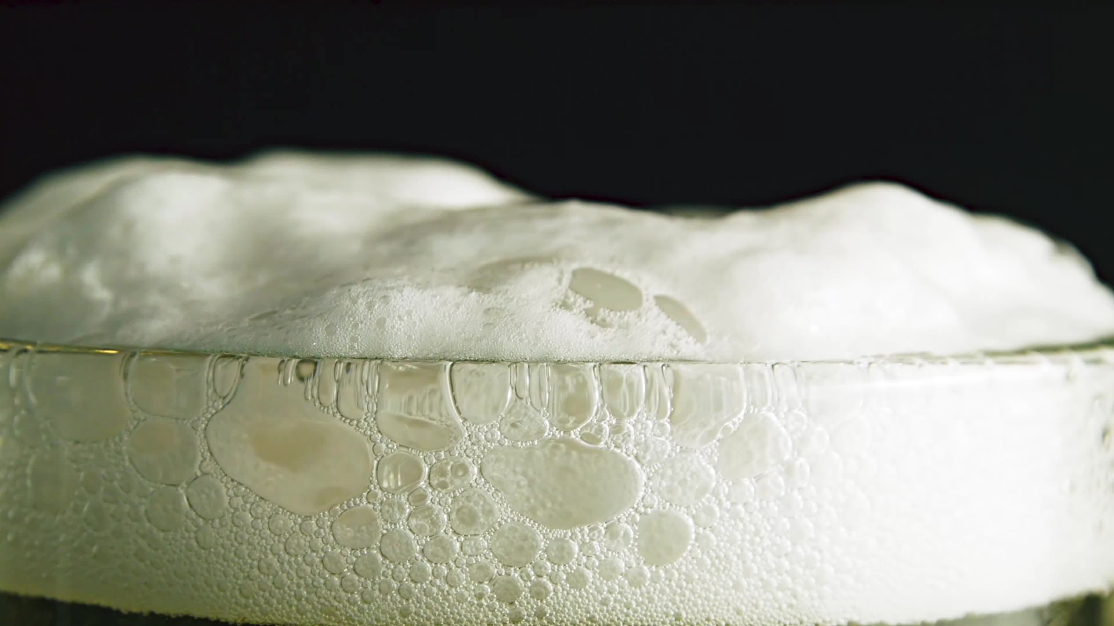 Beer Glass With Overflowing Foam Beer Is Pouring Into Glass On The Wooden Table Dark
