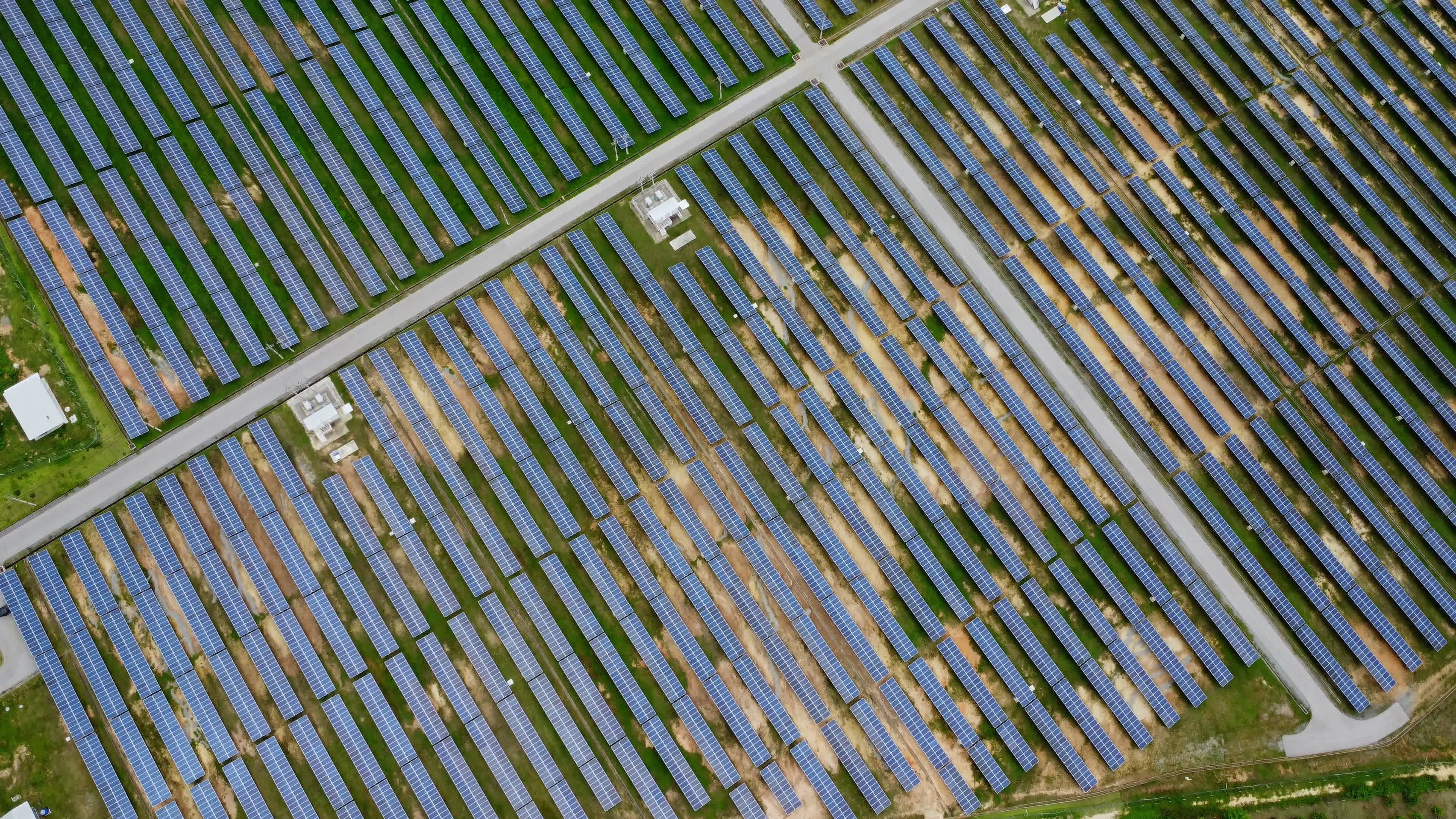 Aerial view of solar power plant on green field. Solar panels system ...