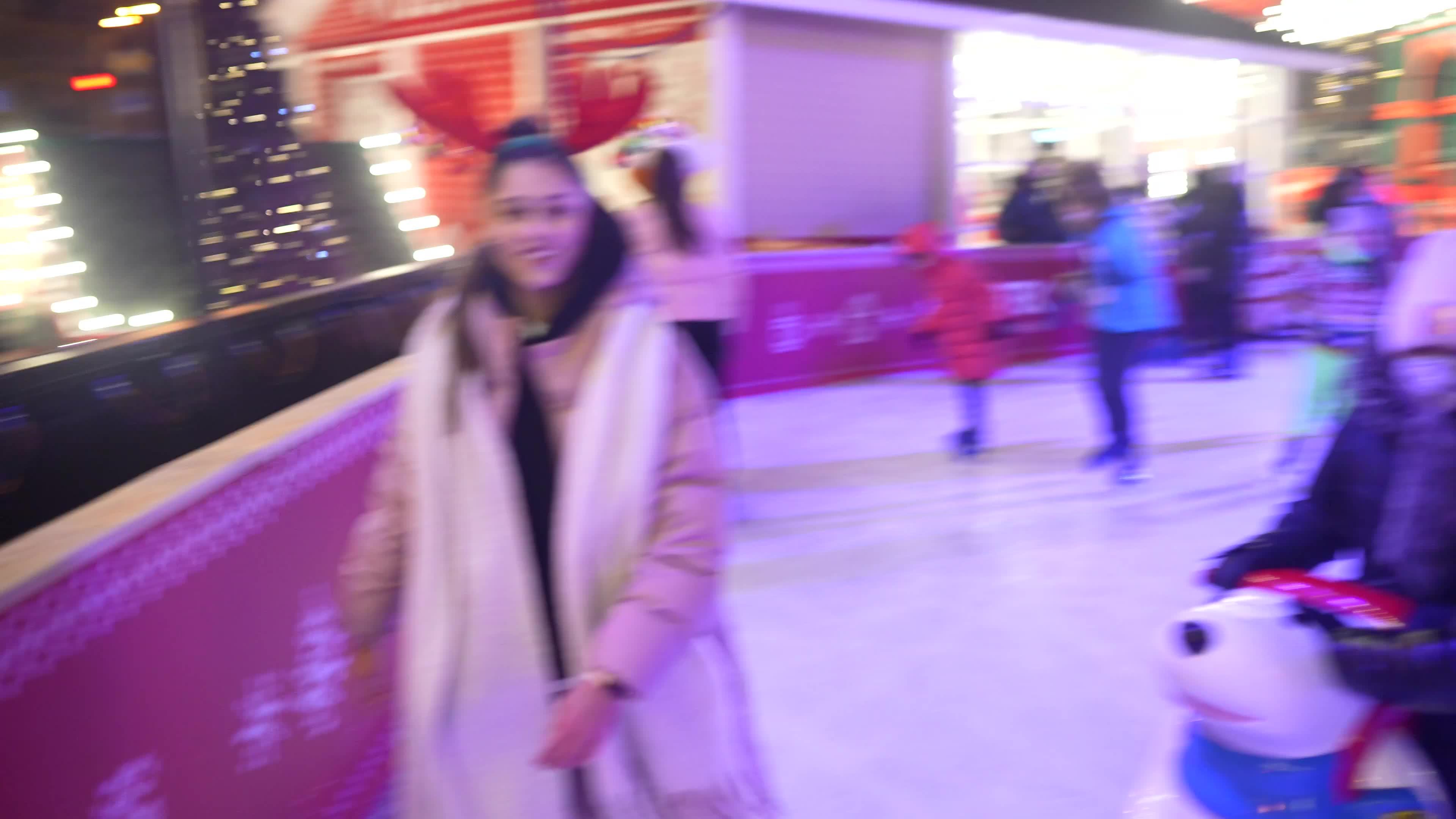 Woman Skating And Laughing In An Outdoor Ice Rink With Festive Holiday Decorations 11743224