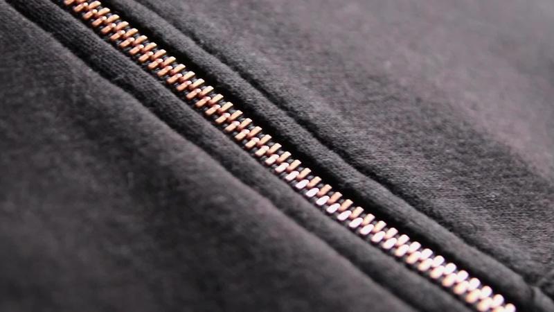 Copper colored fashion zipper in close-up macro view showing black ... Copper colored fashion zipper in close-up macro view showing black ...