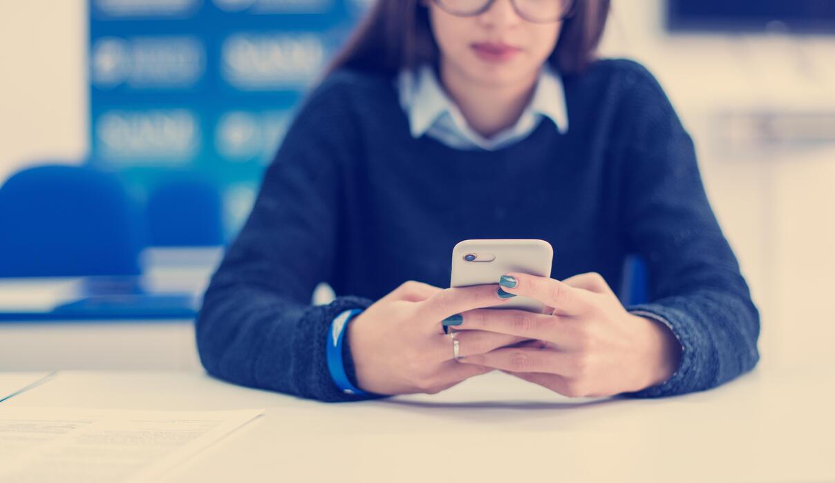 Student On Phone Stock Photos, Images and Backgrounds for Free Download