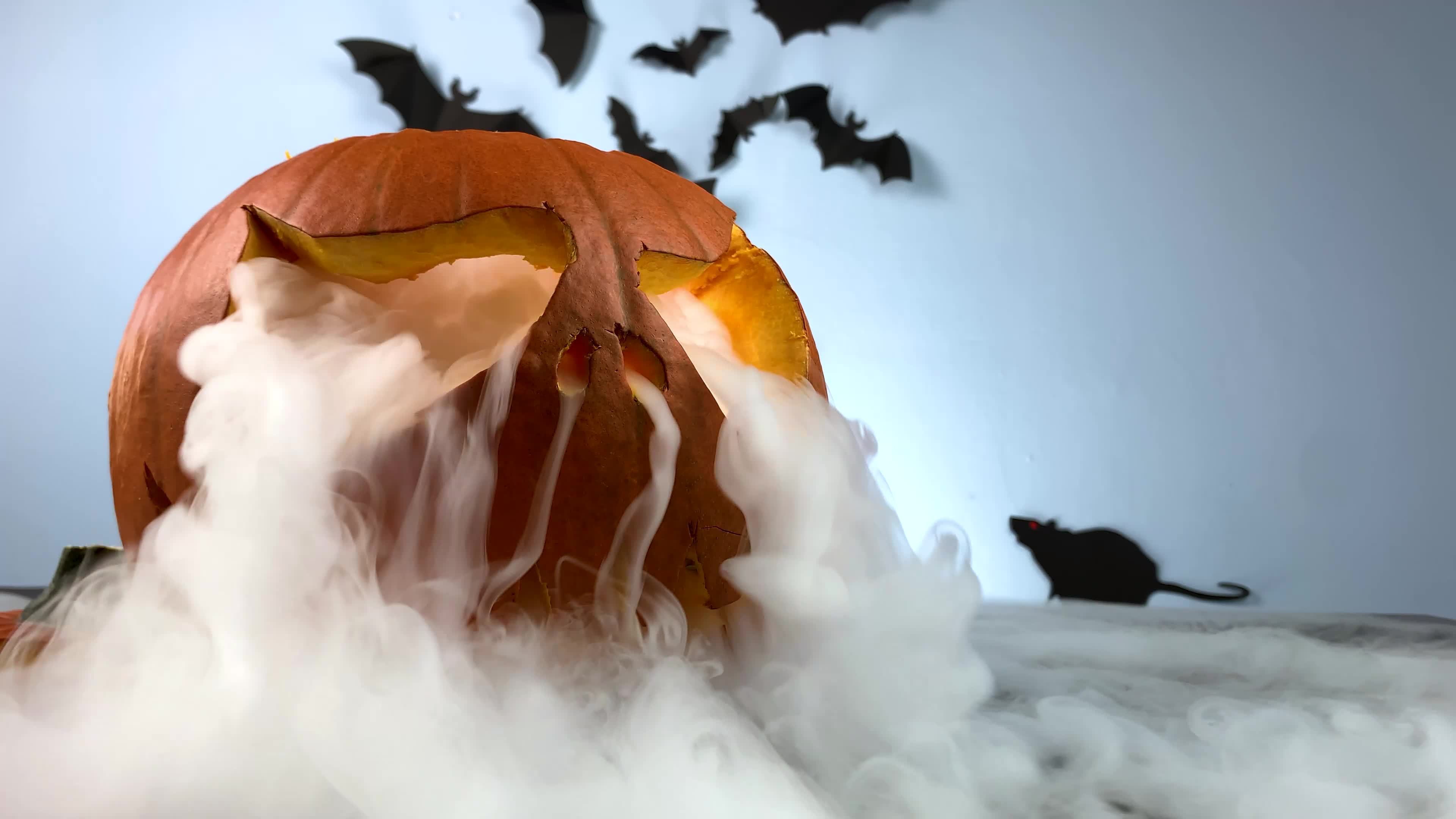 Scary lighting pumpkin on wooden table with dry ice inside. Halloween ...