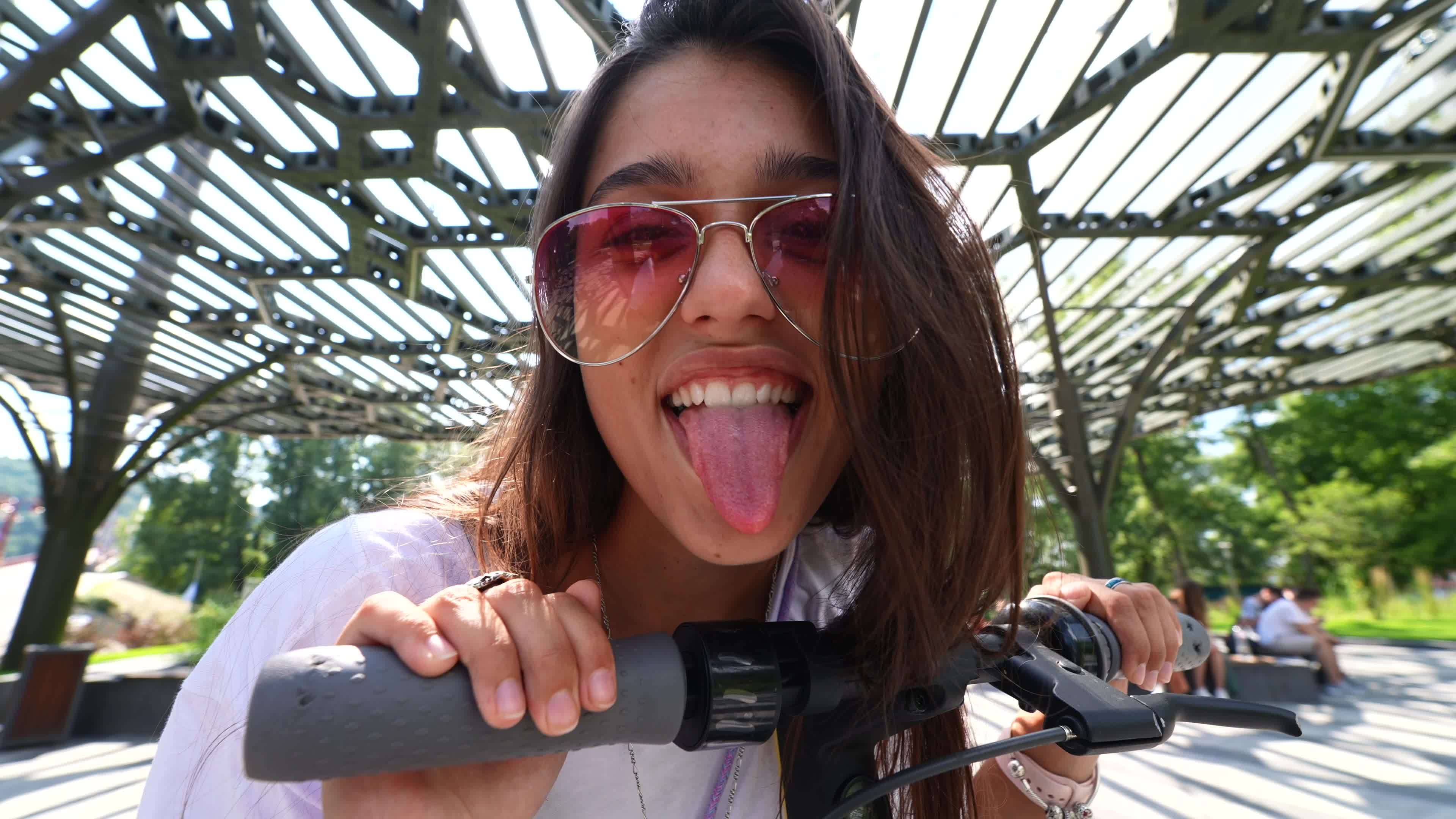 Young Woman Rides Electric Scooter On A Sunny Day 13136345 Stock Video At Vecteezy