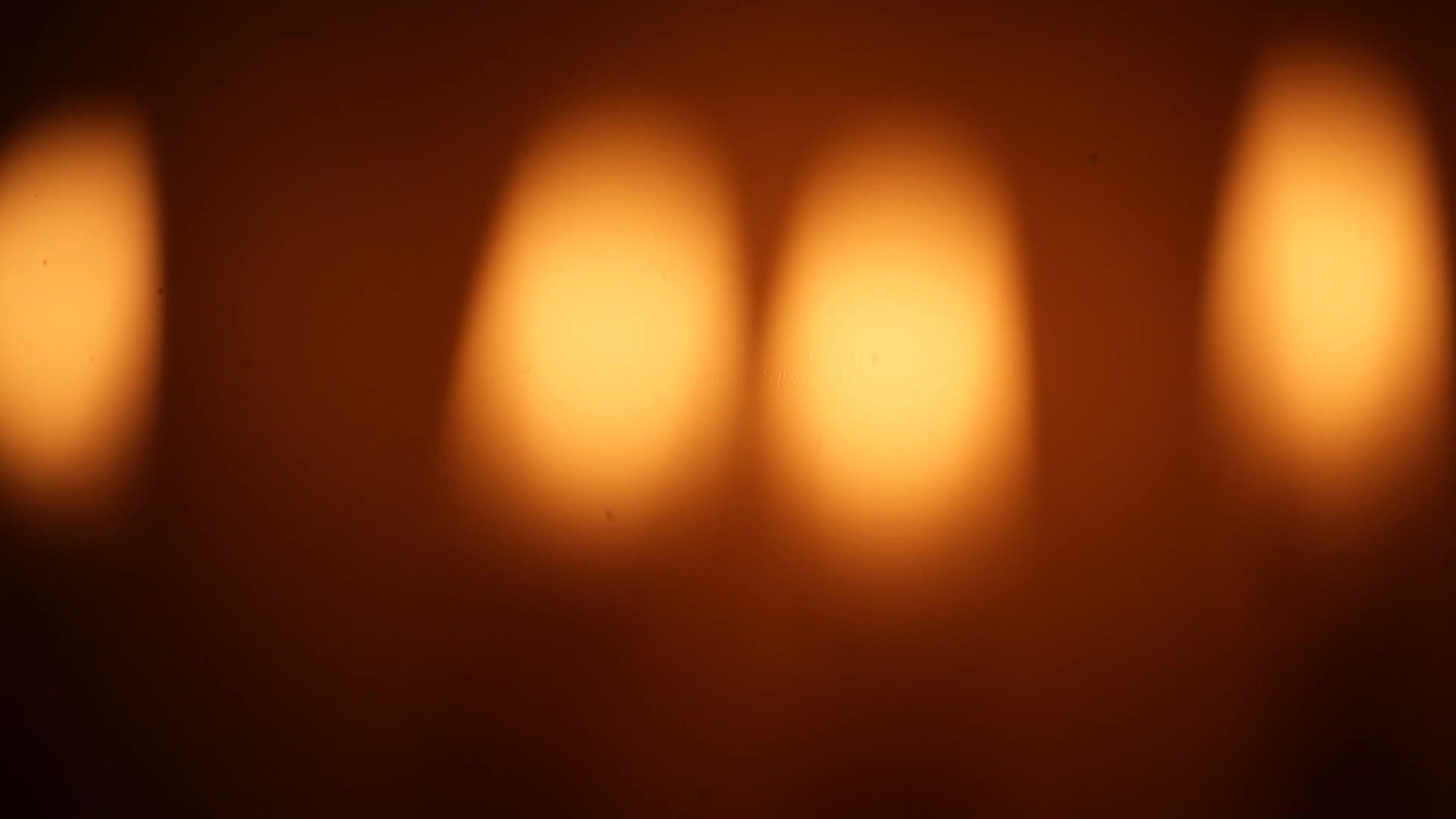 Blurred candle lights. Spot light. Burning candle in dark. Out-of-focus frame. Warm background ...