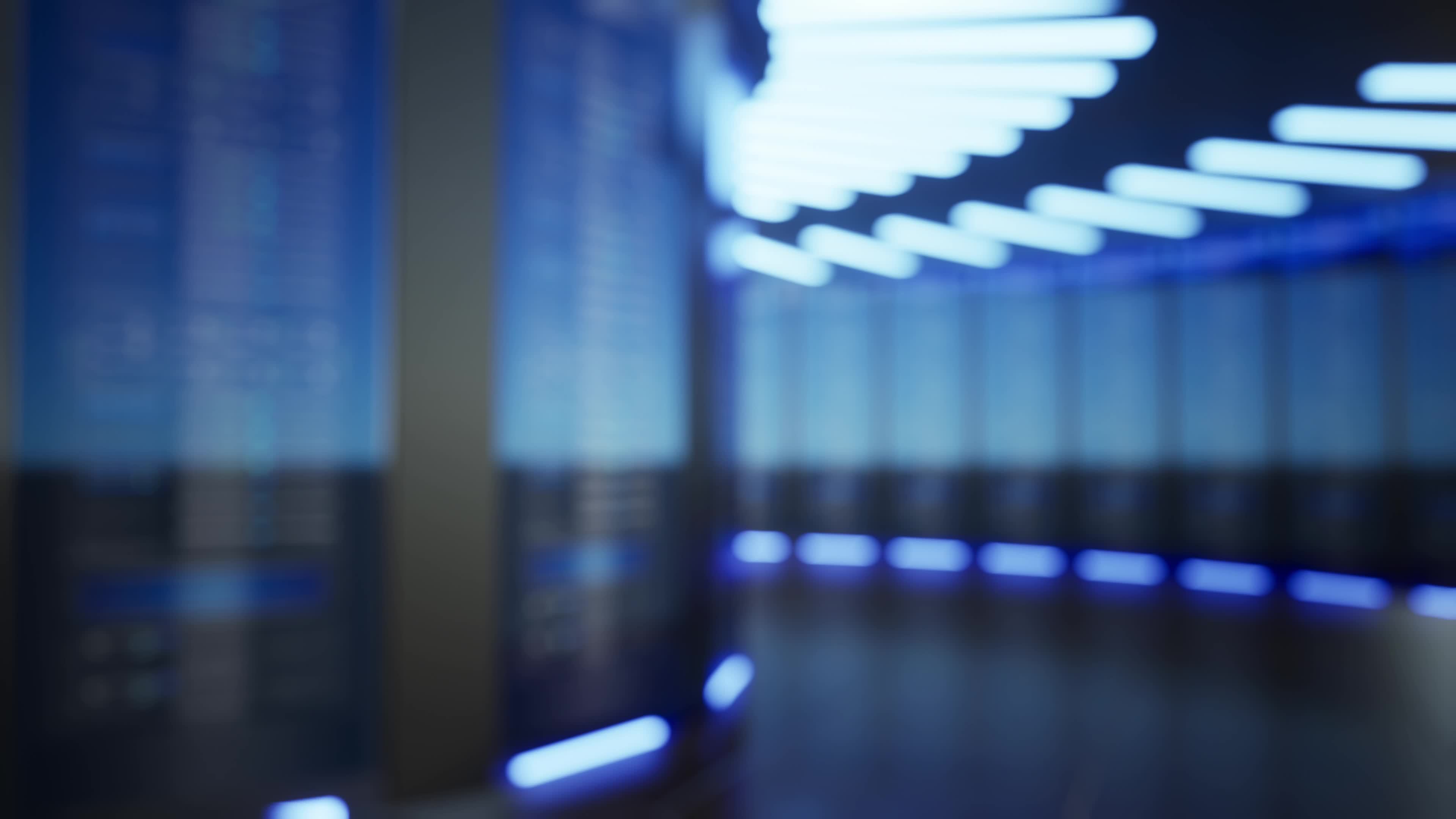 Network and data servers behind glass panels in a server room of a data ...