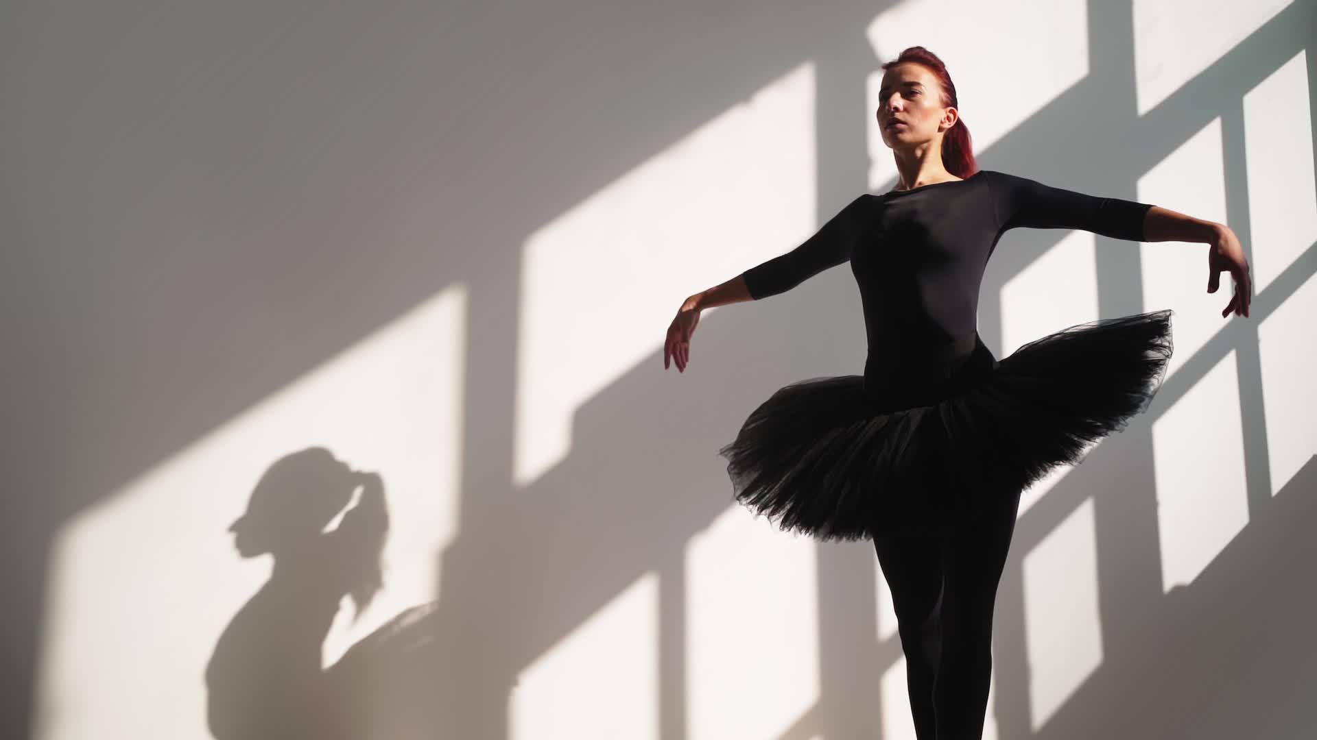 Beautiful Ballerina In A Black Tutu And Pointe Shoes Gracefully Dances