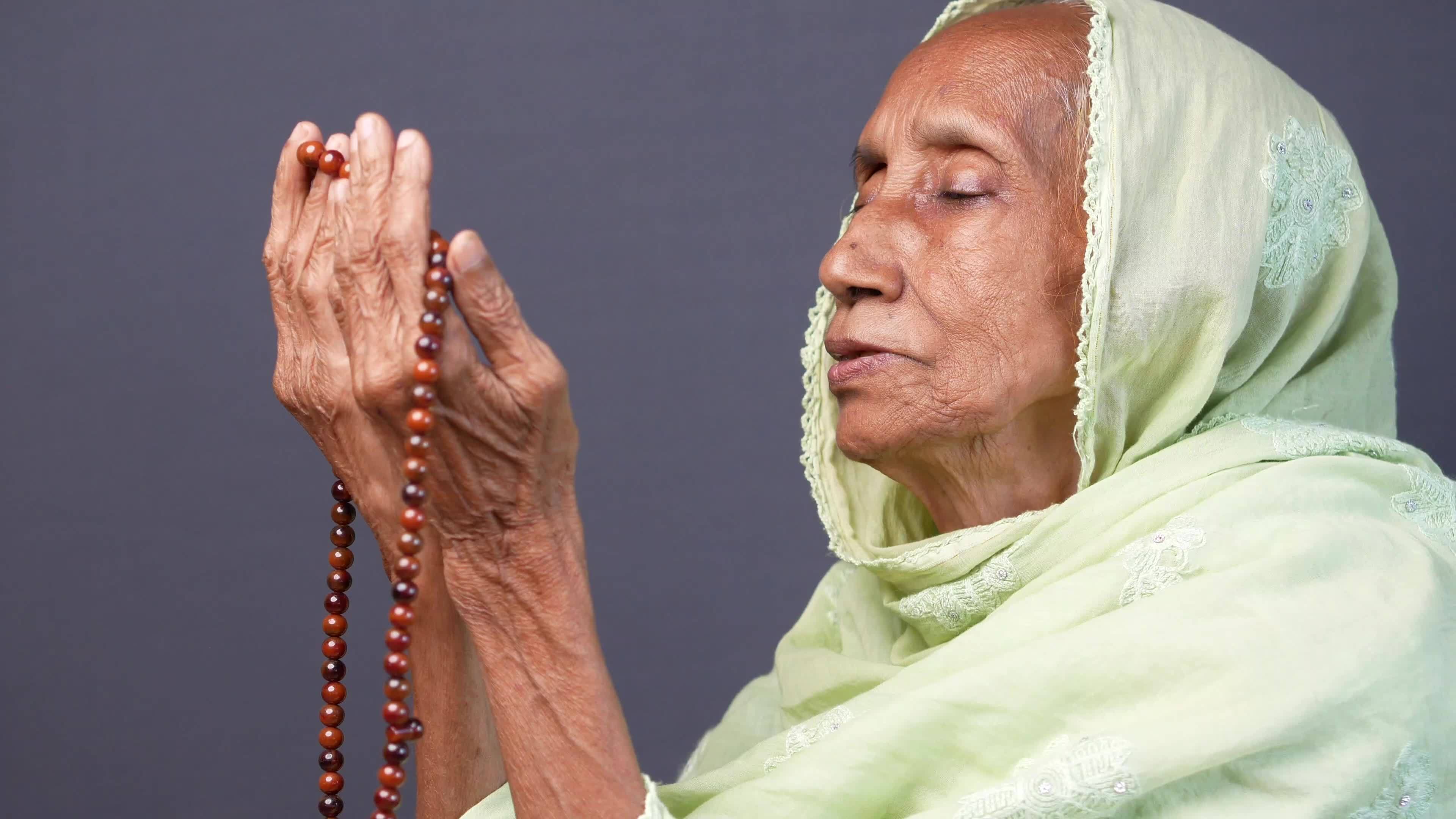 Mature woman prays 14181437 Stock Video at Vecteezy