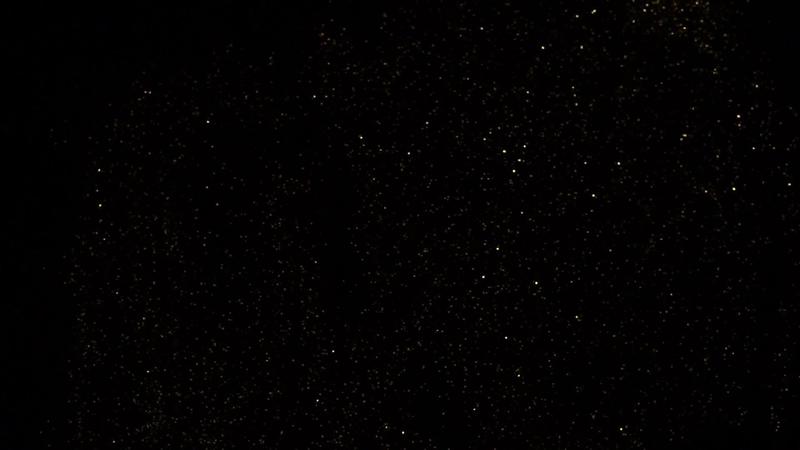 Sparkling star in dark space for video overlay effect. Abstract glitter texture animation for ...