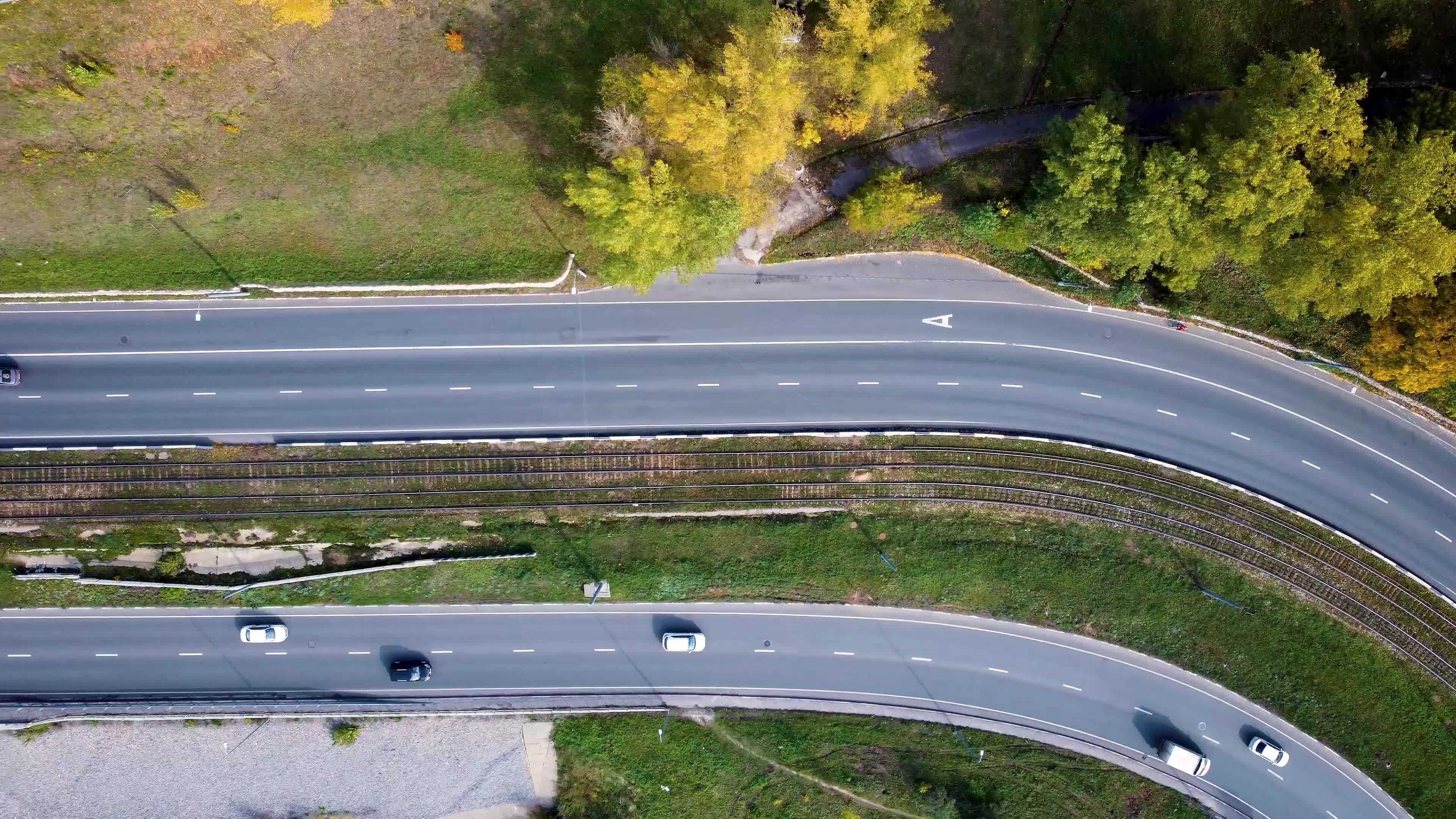 bird's-eye view of the road with an autumn forest and a road slot. 14638026 Stock Video at Vecteezy