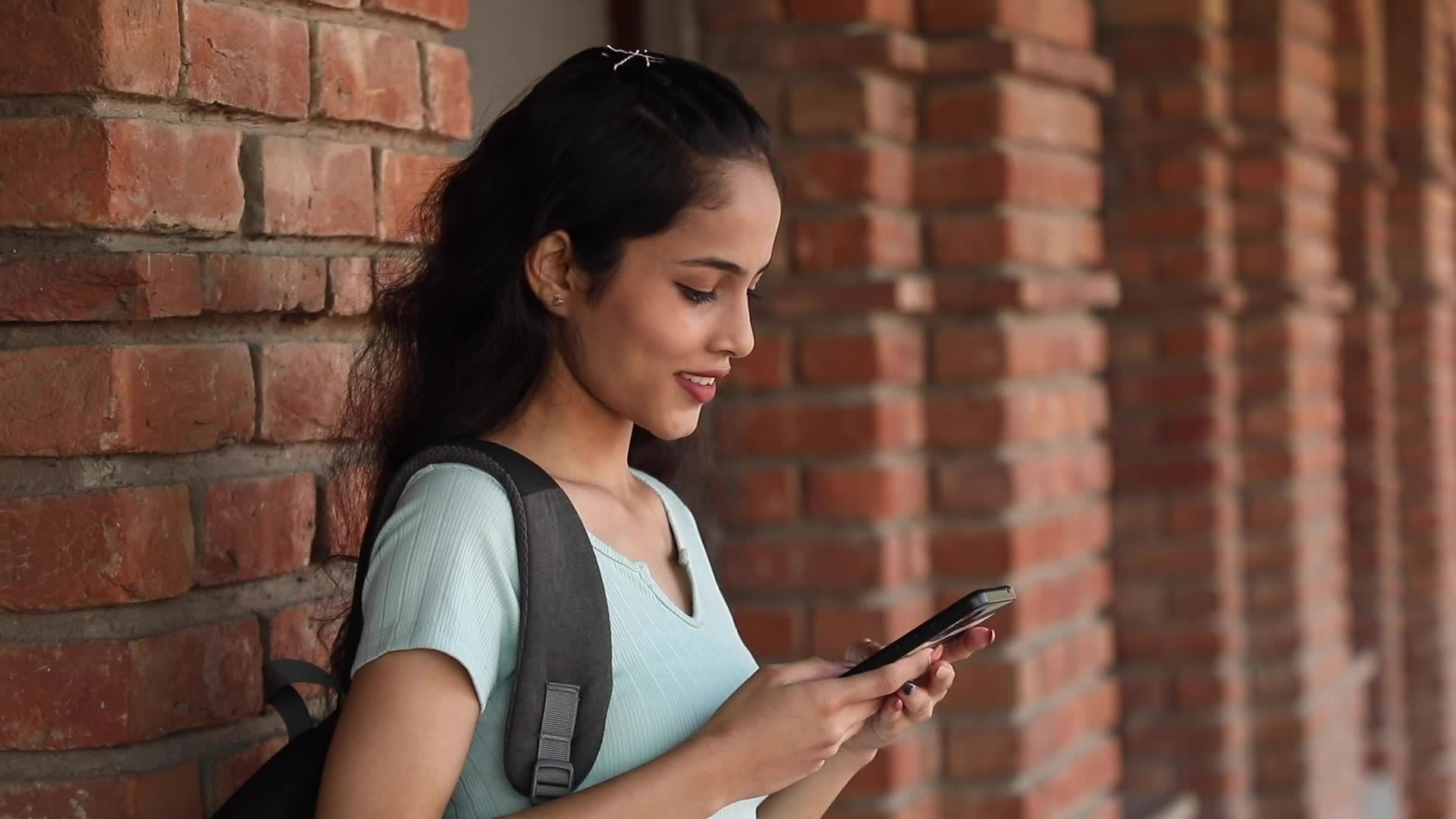 Video Clip Of A Smiling Asian Female College Girl Using Her Mobile Phone Near The College Campus
