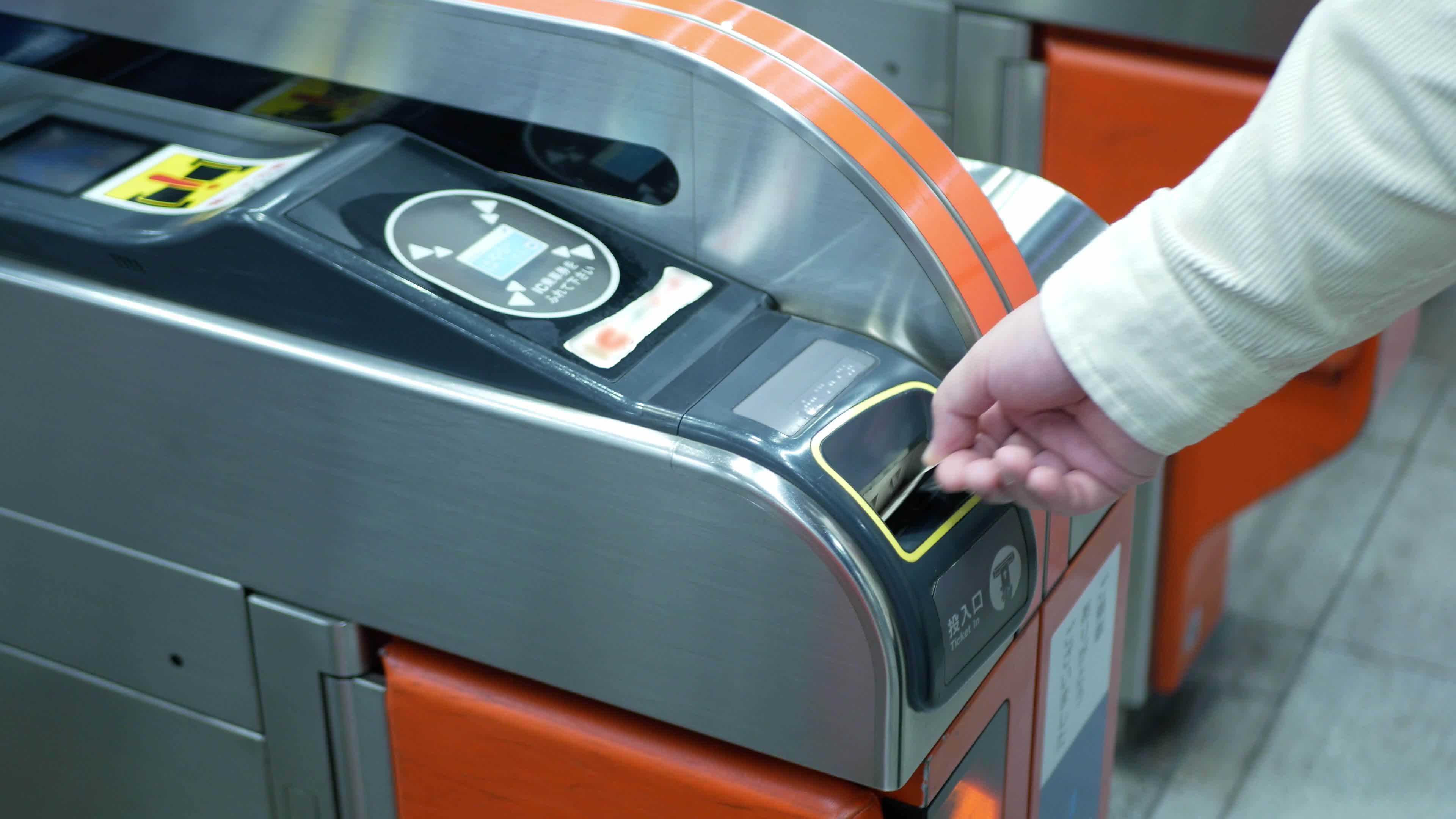 Passengers are going through automatic entrance ticket gate door to the ...
