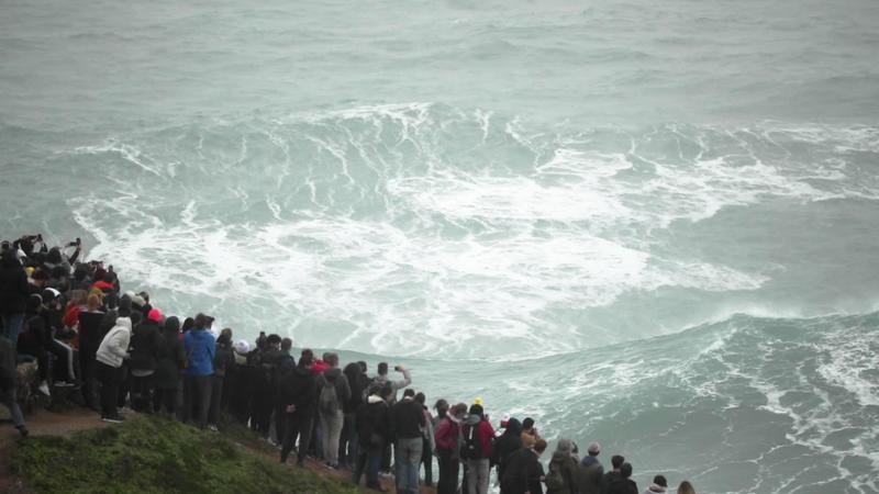 Nazare Portugal - Tourists Watching The Stunning And Famous Big ...