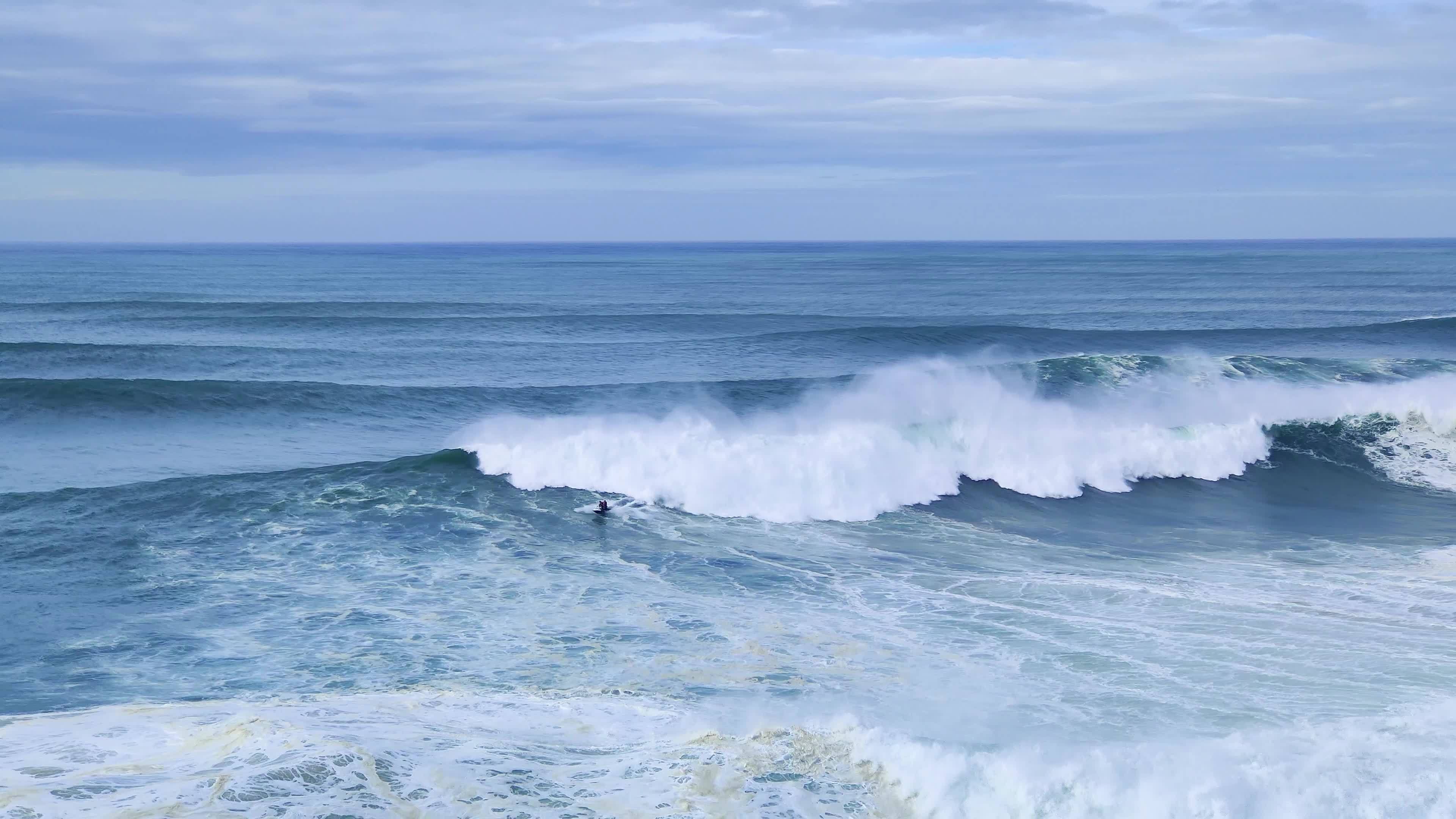 Surfer is riding a giant big wave in Nazare, Portugal. Biggest waves in ...