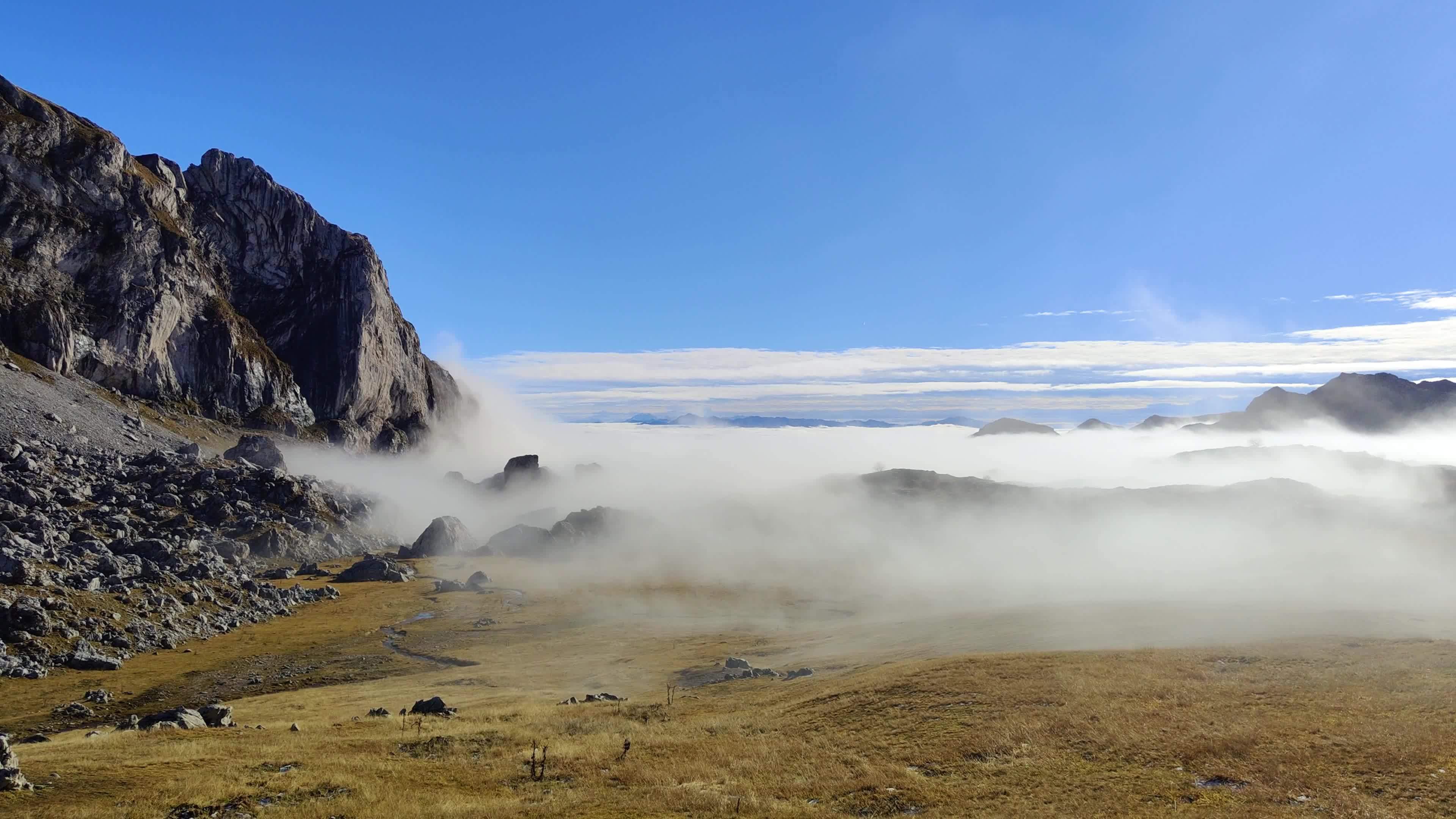 Beautiful landscape scene on the mountain in clouds and fog passing ...
