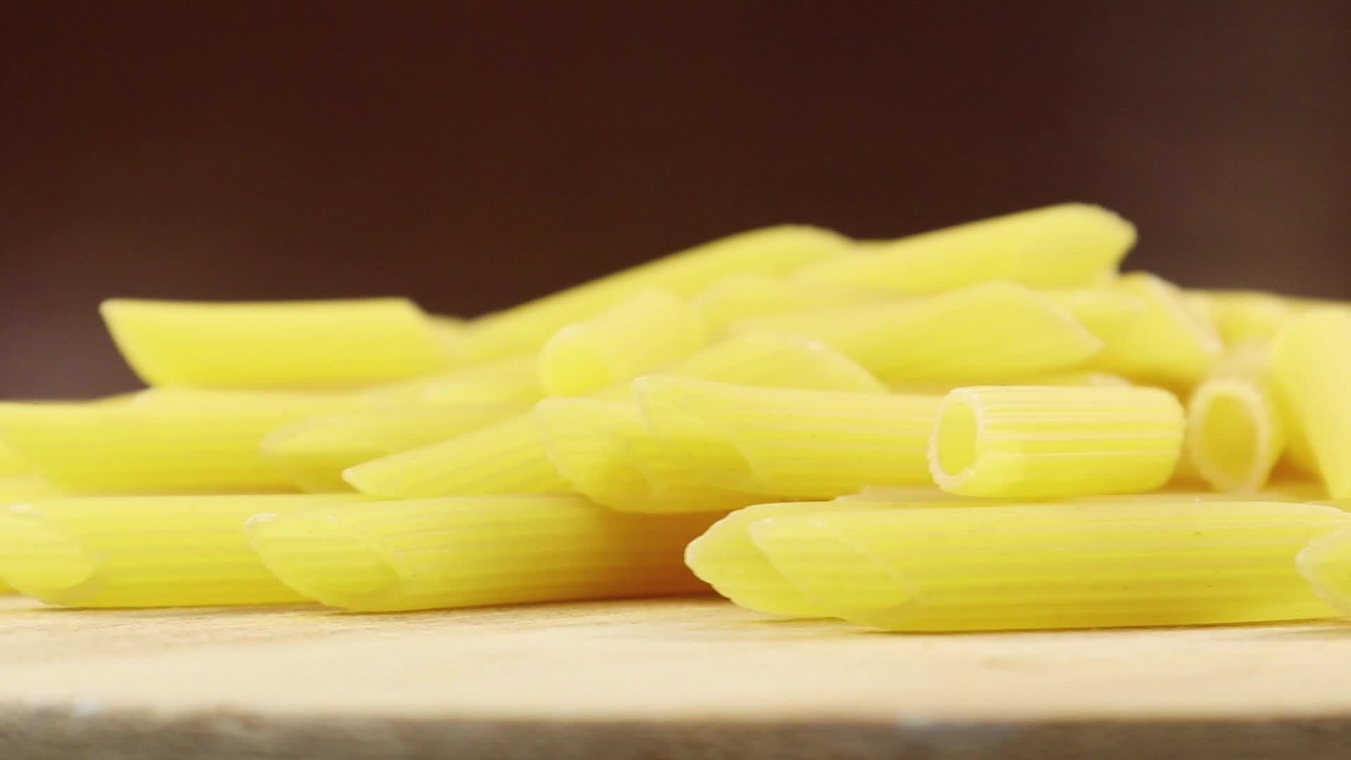 Slowly Spinning Raw Penne Rigate Is A Short Pasta With Oblique Cuts And A Ribbed Surface