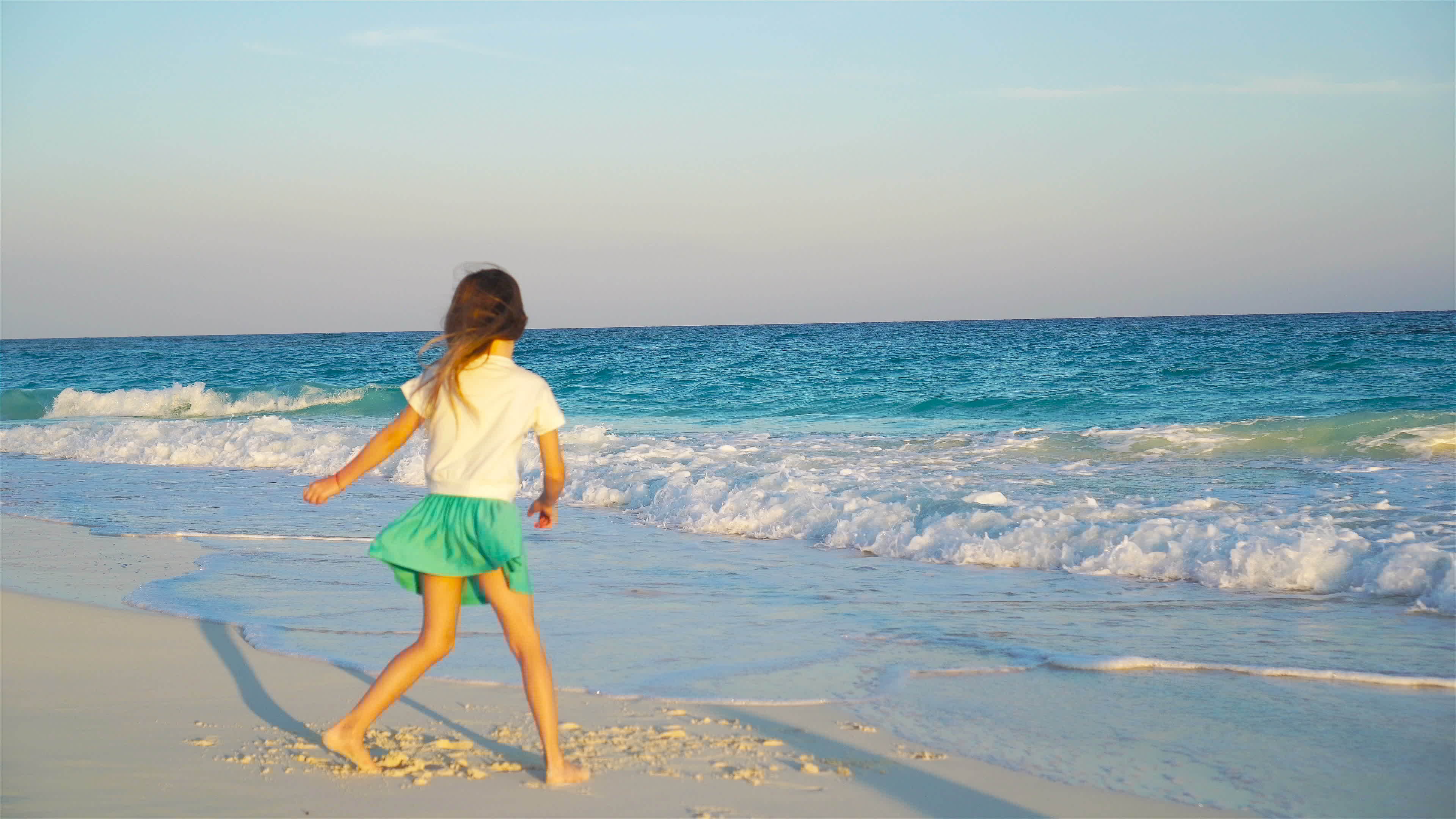 Adorable happy little girl on white beach at sunset 19627029 Stock Video at Vecteezy