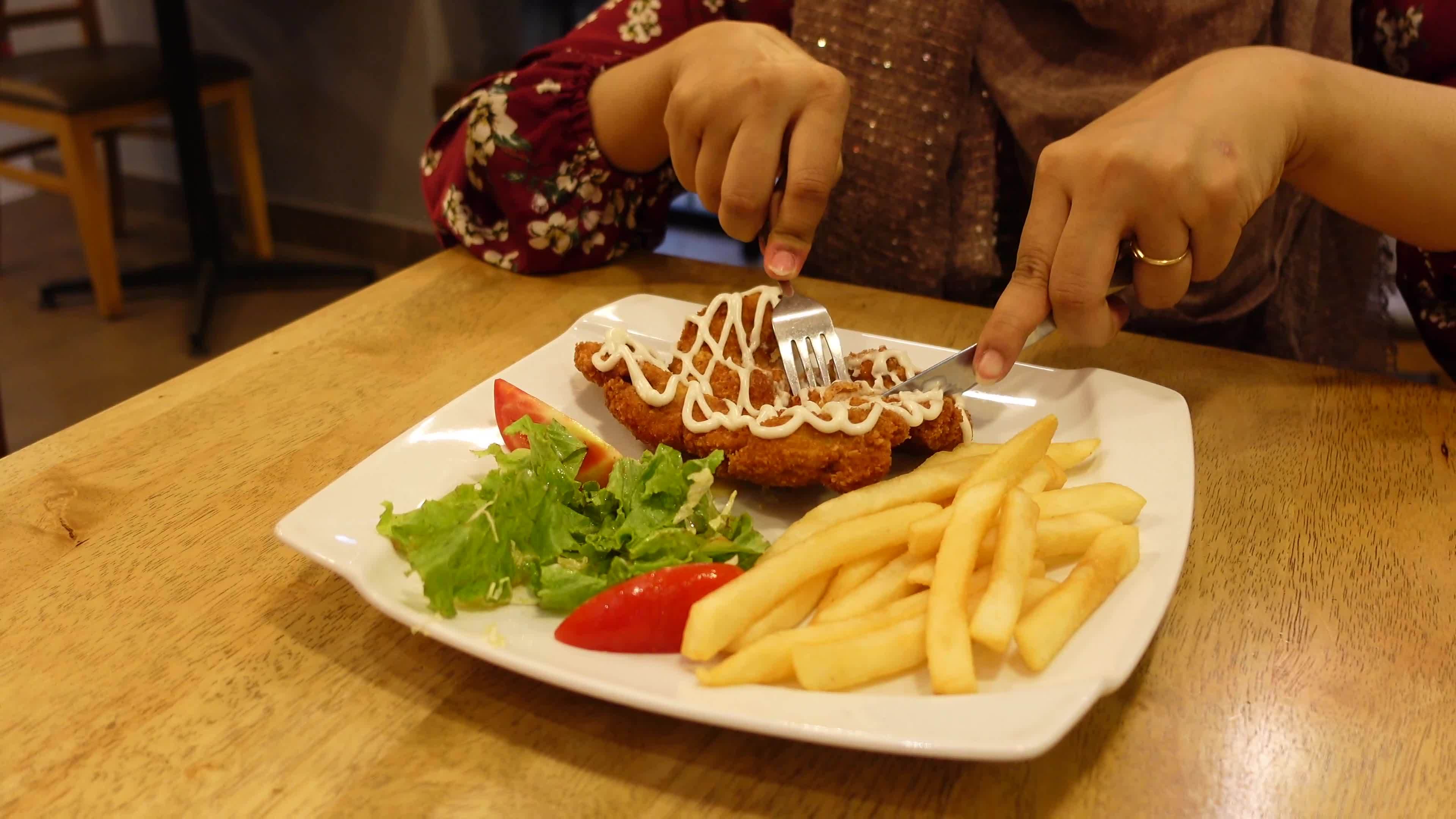 Woman eating beef steak meat with vegetables on a plate 19919284 Stock Video at Vecteezy
