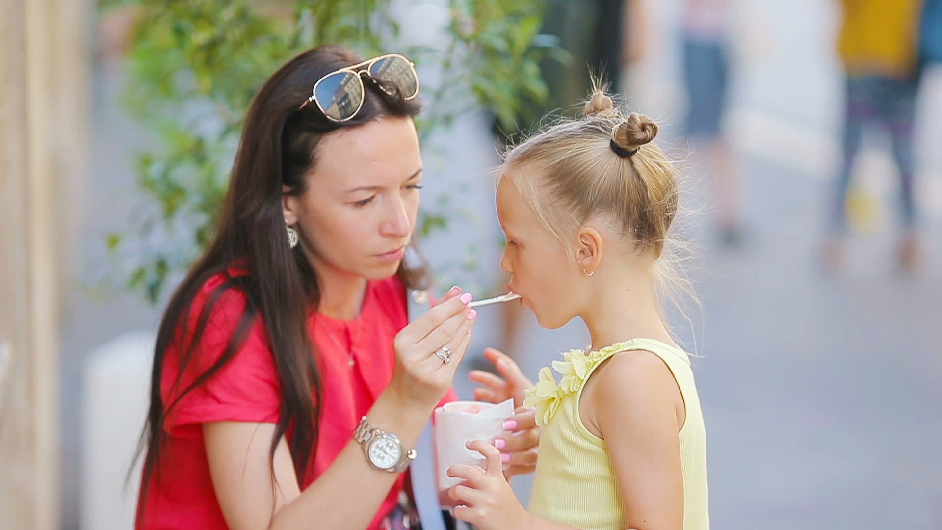 Young Mother And Her Daughters Eating Ice Cream Outdoors Mum Feeds His