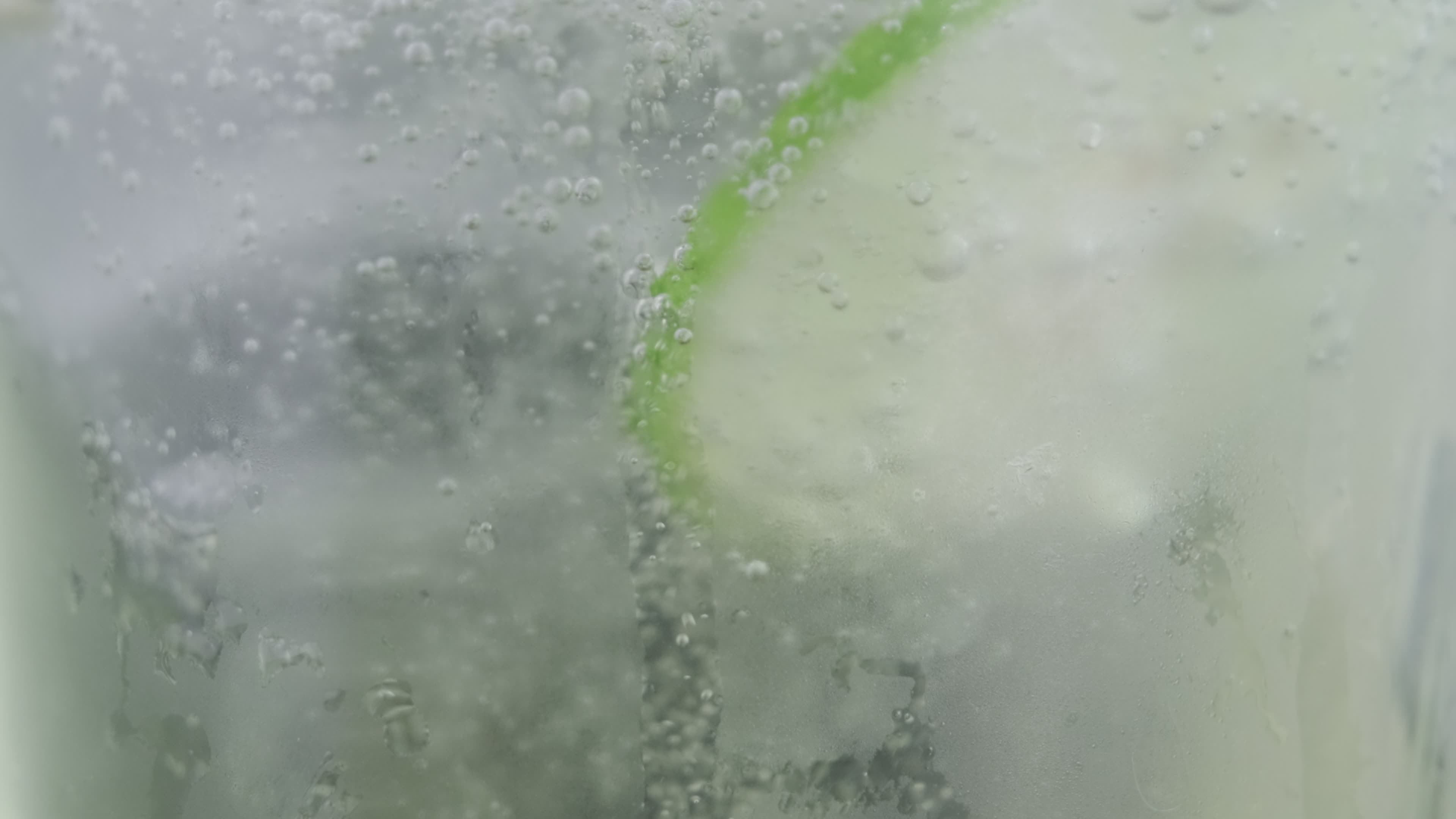Shot Of Hand Pouring Cold Tequila From A Bottle With Lemon And Salt On