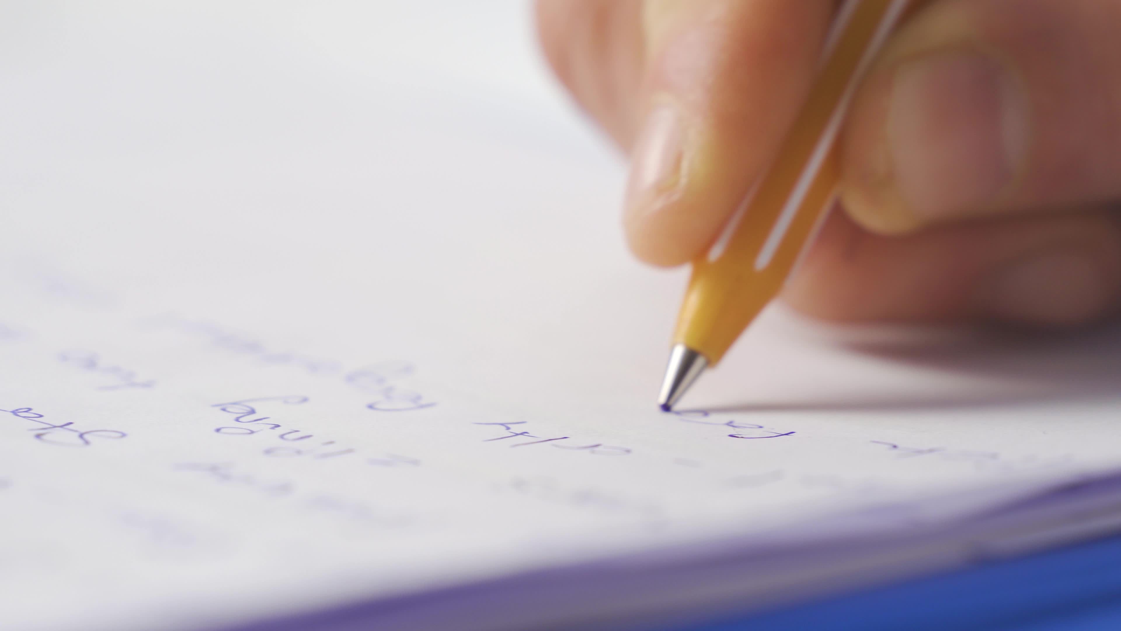 Close-up of hand writing notes in the office. Writing, writing letters ...