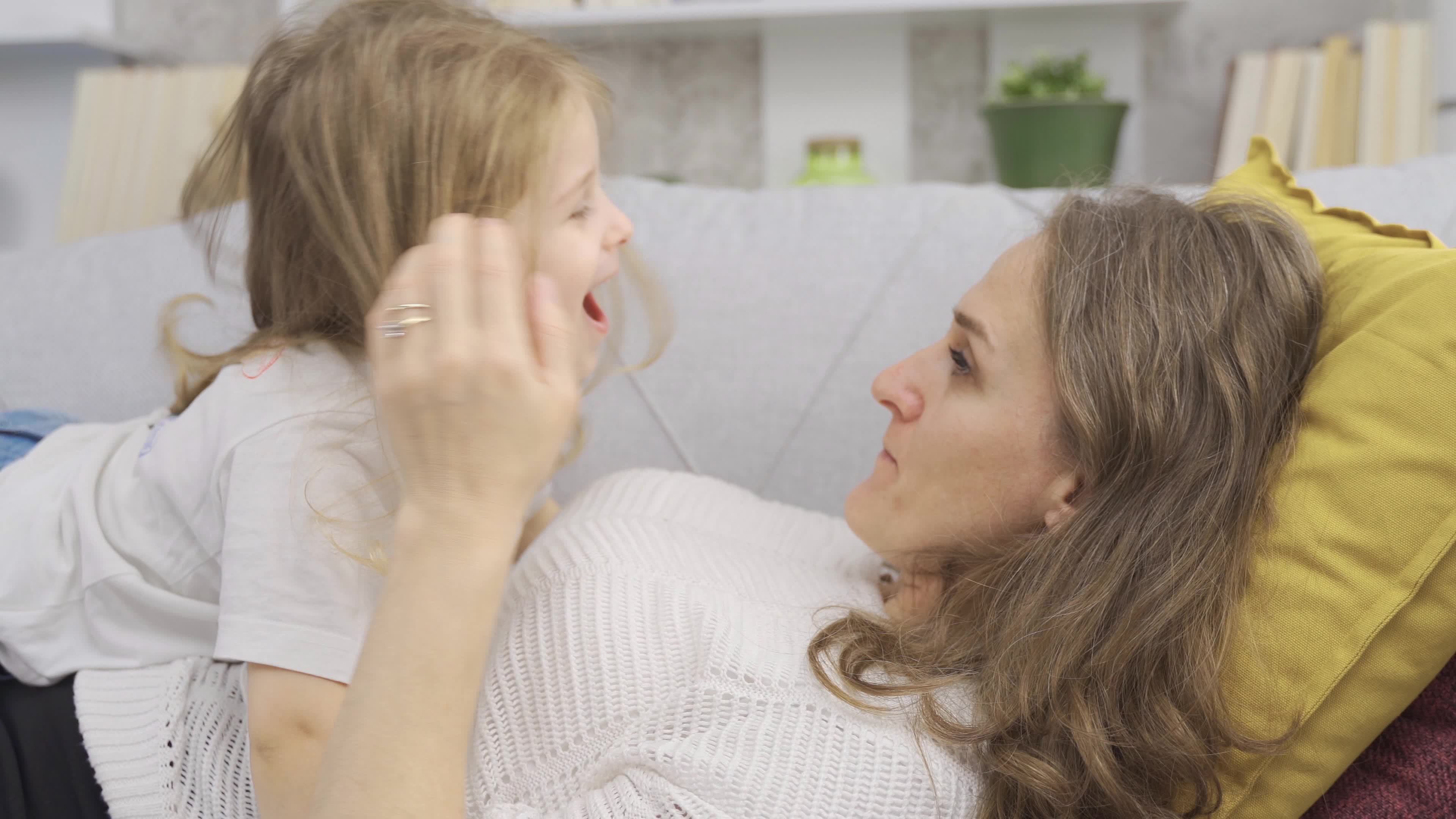 Mother And Daughter Lying Down Hugging Each Other Happy Mother And