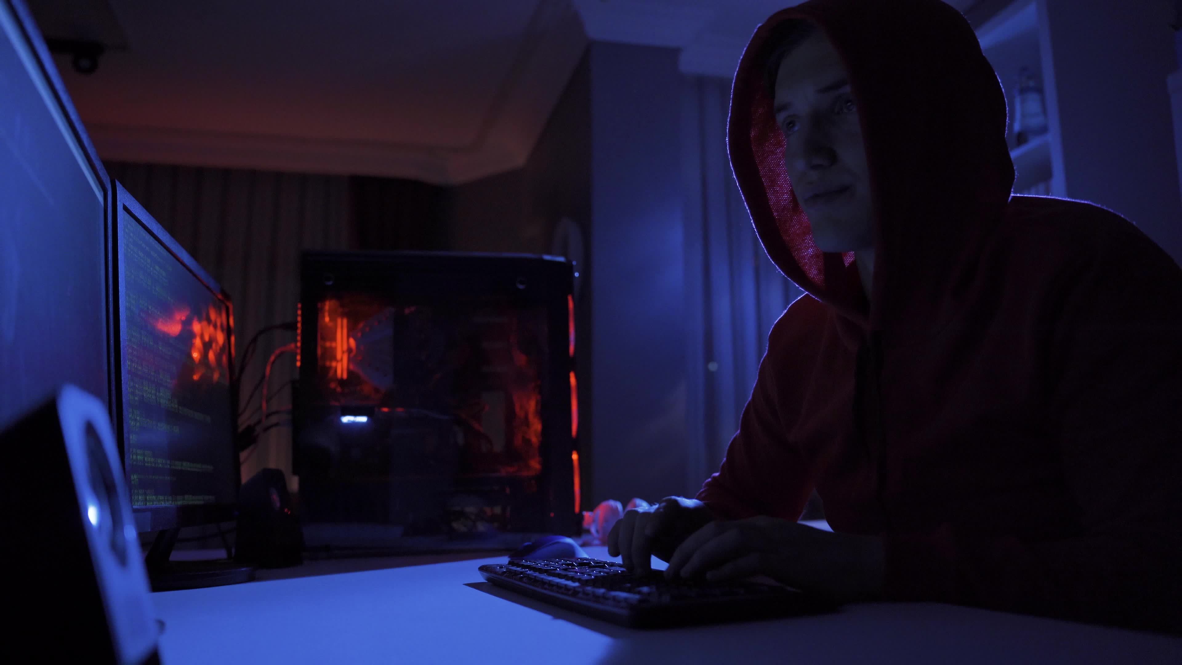 Background Of Male Hacker Using Computer To Commit Crime Hacker Bypasses Cybersecurity By