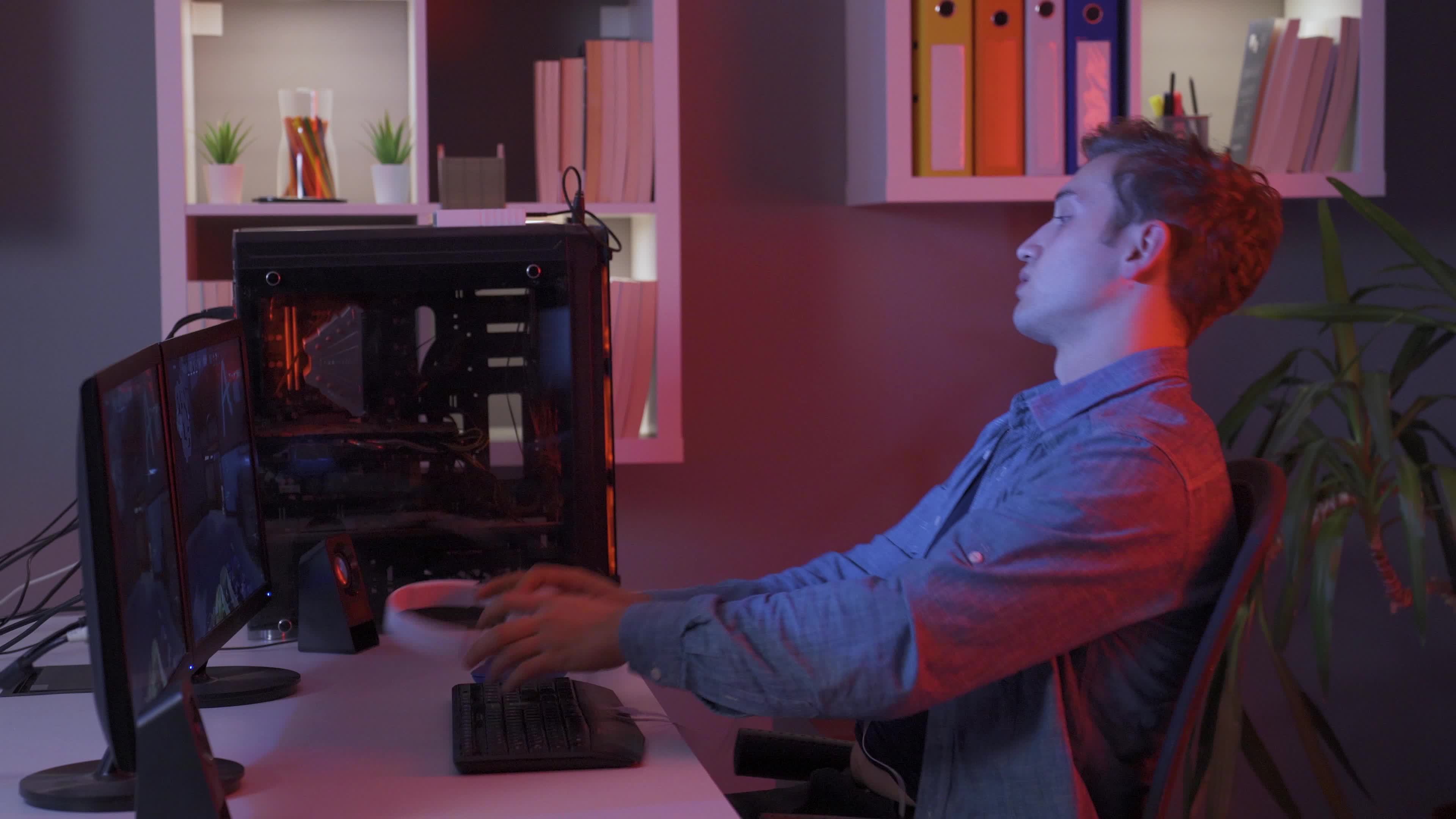 Aggressive, losing young man playing video game on his computer. Young ... Aggressive, losing young man playing video game on his computer. Young ...