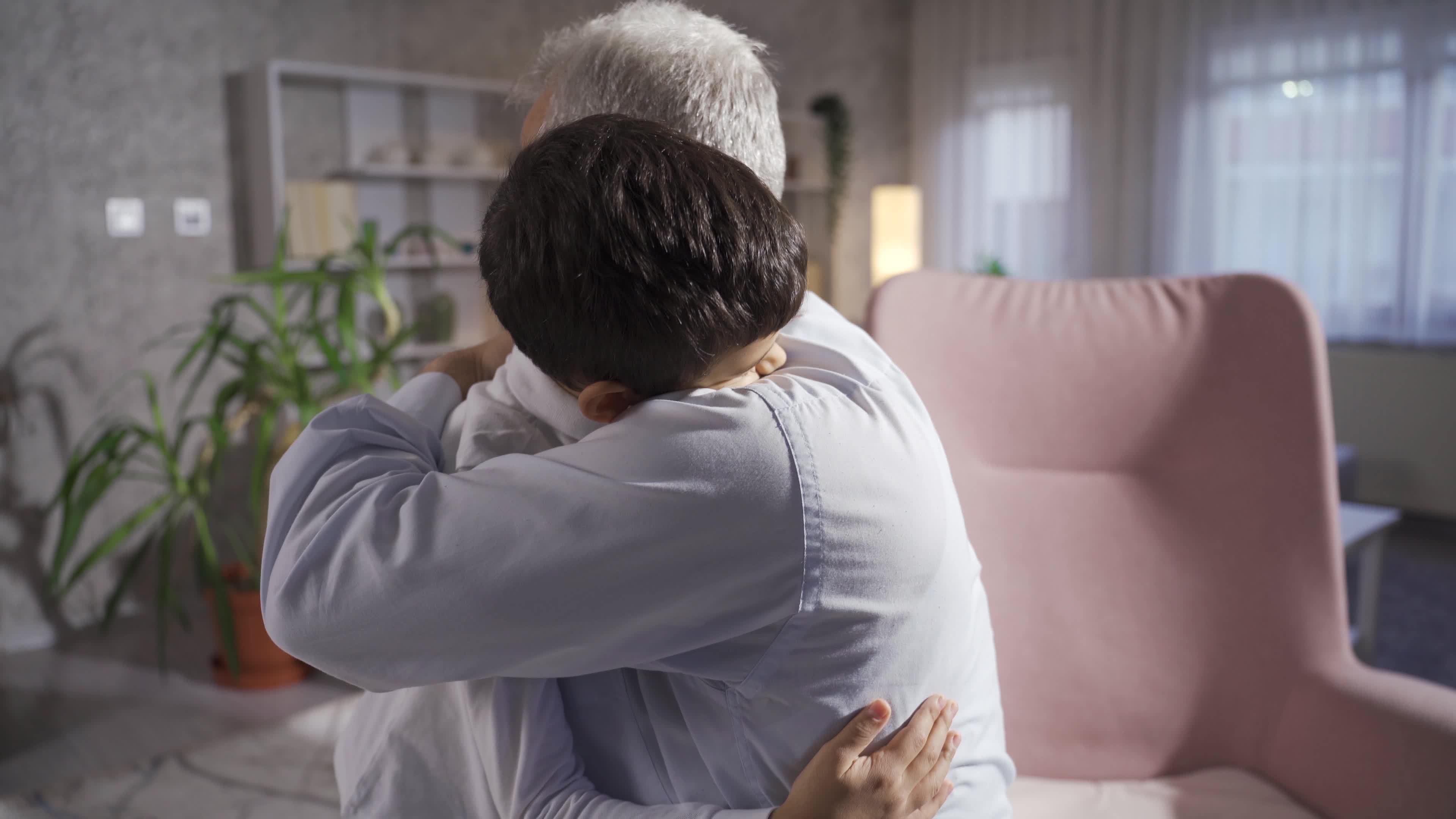 The son runs and hugs his father. Father and son hug each other ... The son runs and hugs his father. Father and son hug each other ...