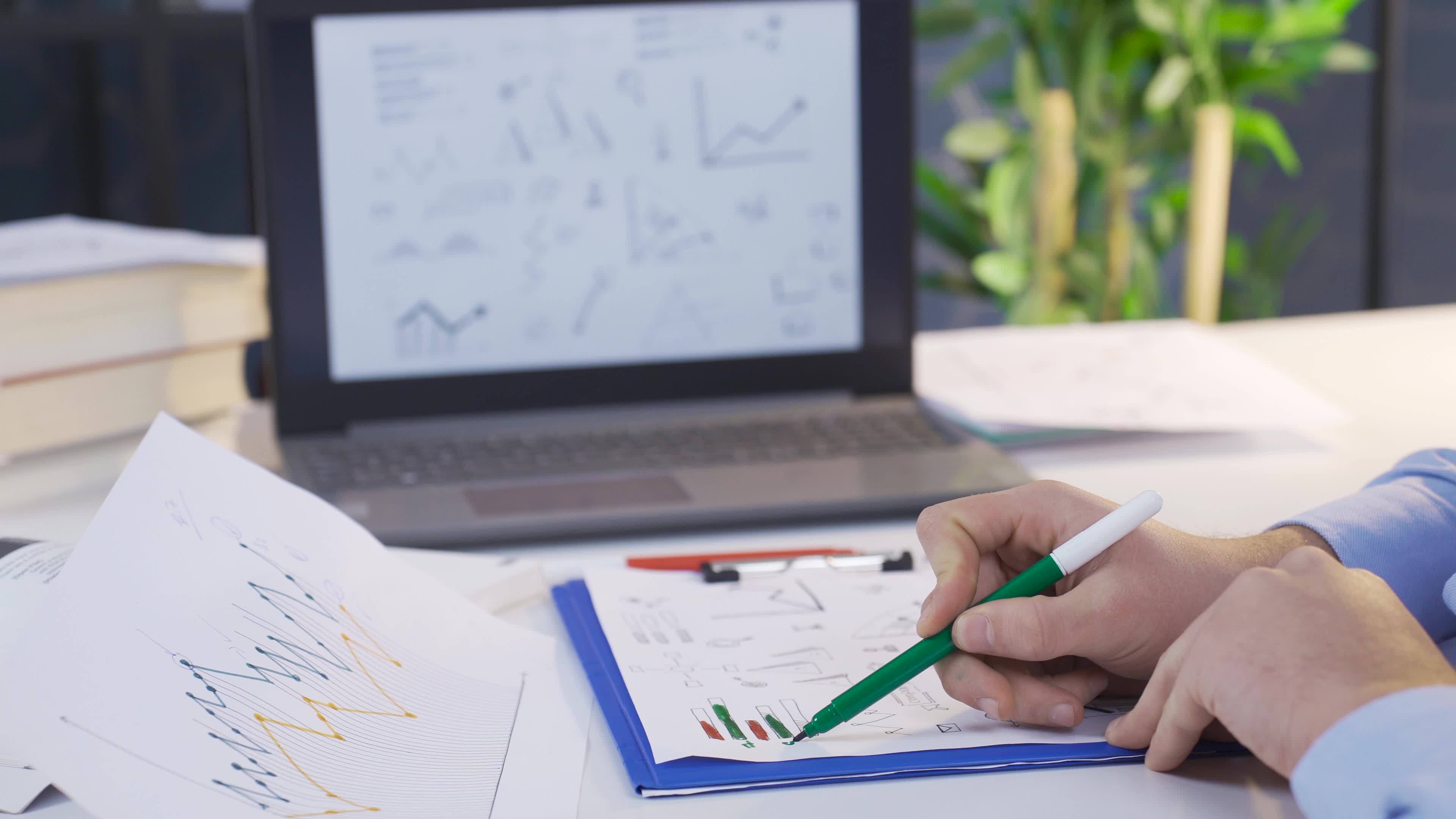 Analyzing charts. Financial Data, Reading. Businessman working with ...