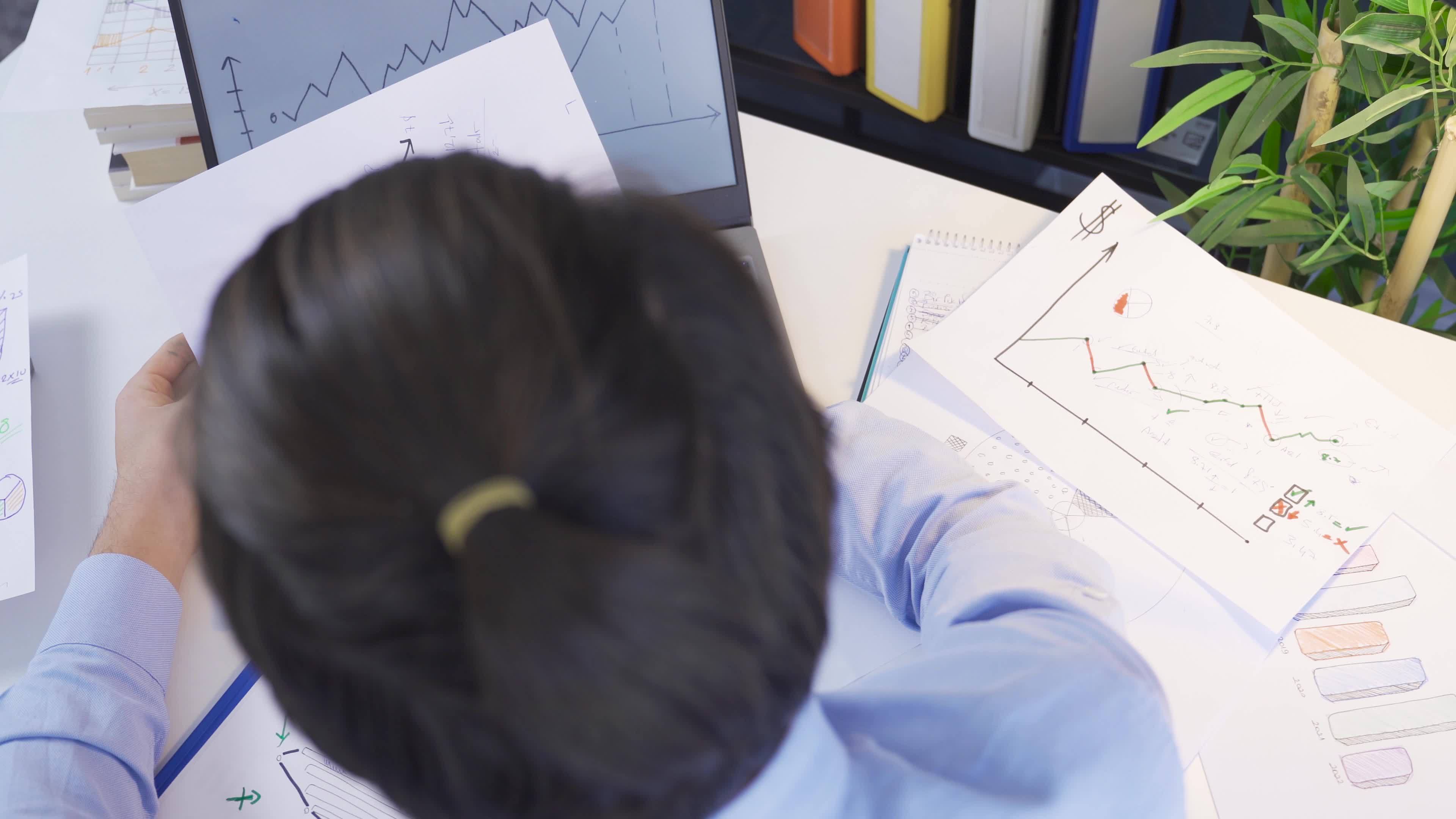 Man Analyzing Financial Statistics. Man comparing and analyzing digital ... Man Analyzing Financial Statistics. Man comparing and analyzing digital ...