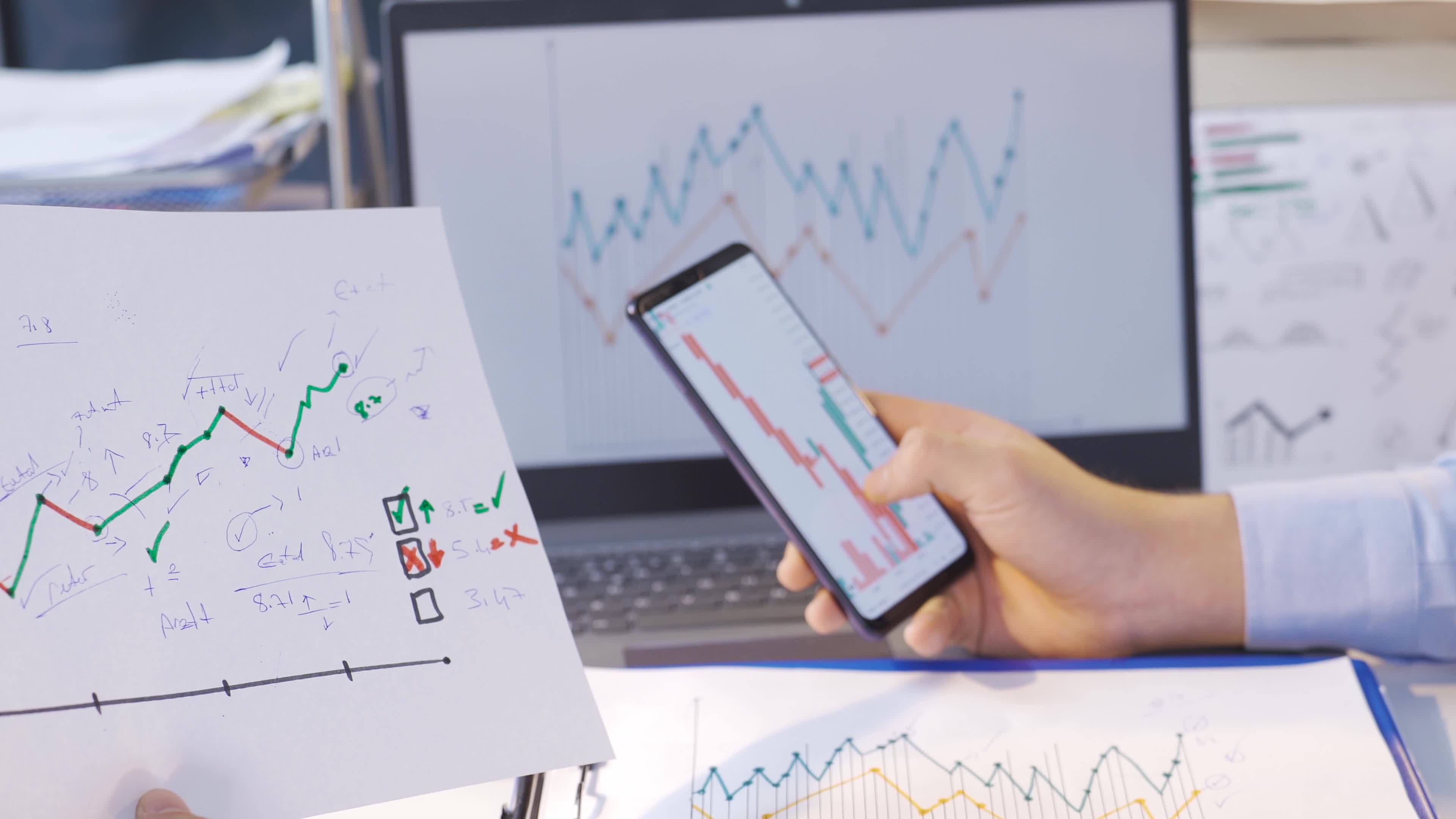 Reading and analyzing stock market charts. The trader looks and ...