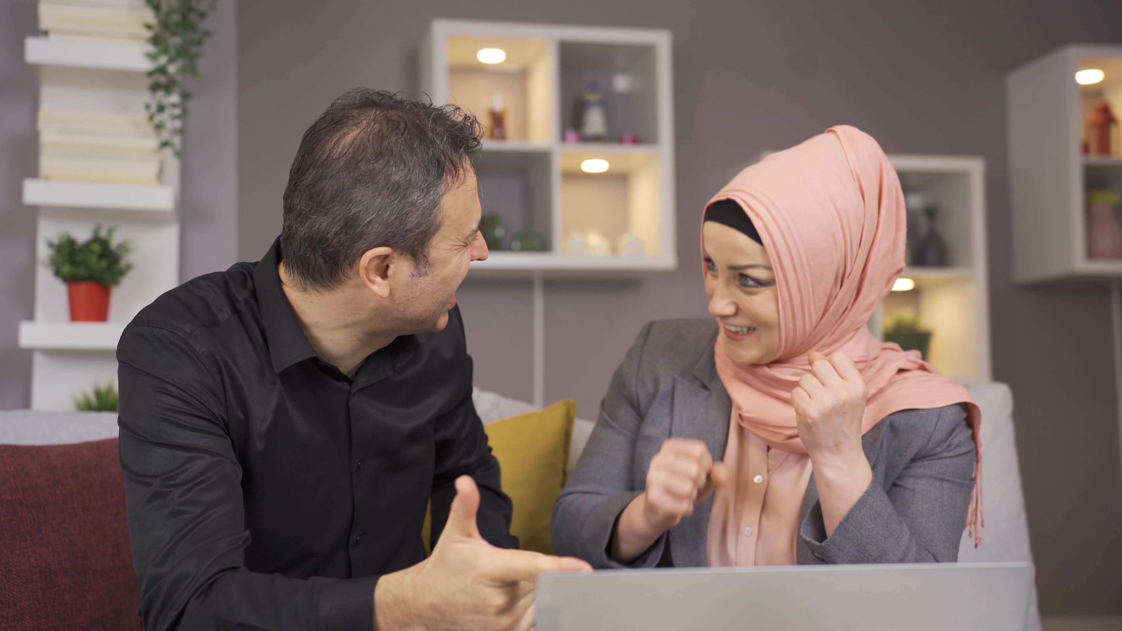 Muslim husband and wife rejoice. Receiving good news. The Muslim couple ...