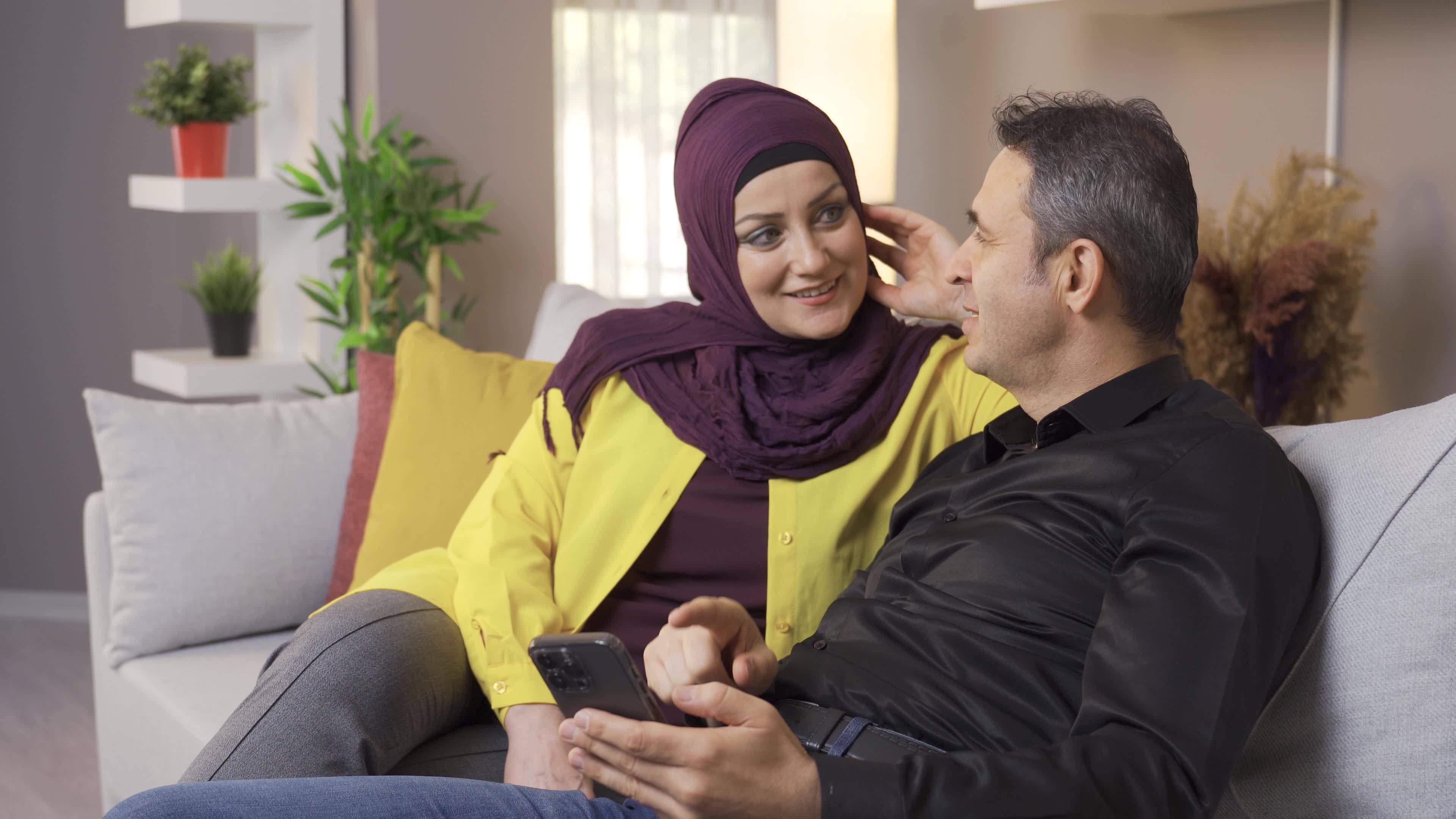 Happy muslim husband and wife spending time at home. Muslim couple ...