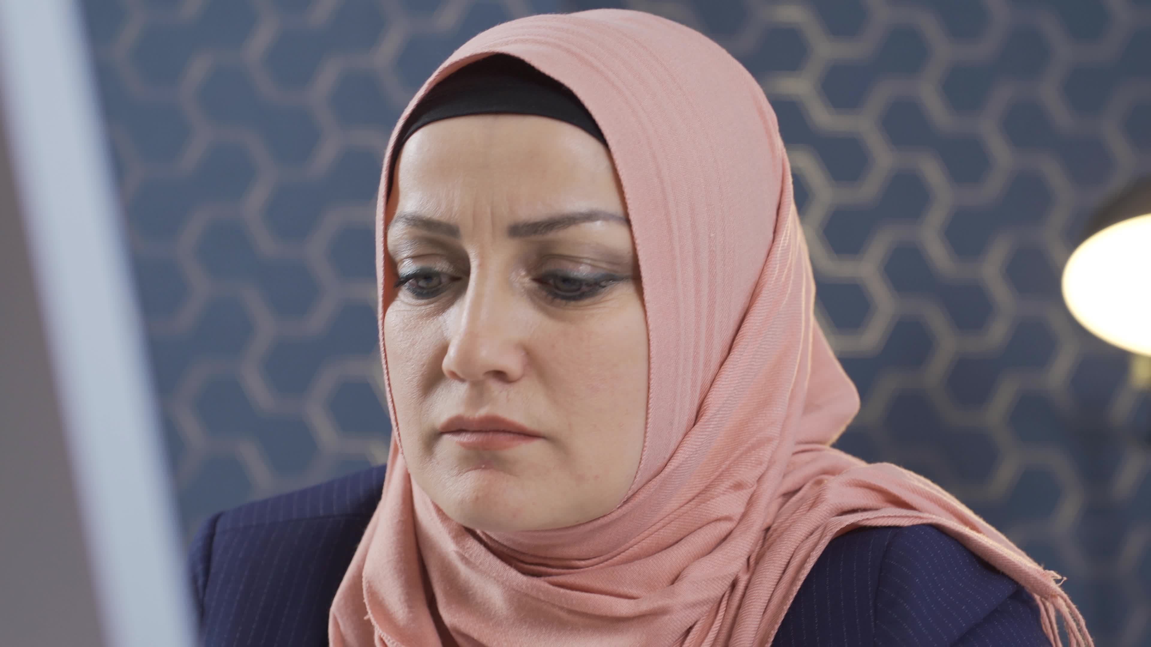 Business woman in hijab focusing on computer in office. Business woman in hijab is working at ...