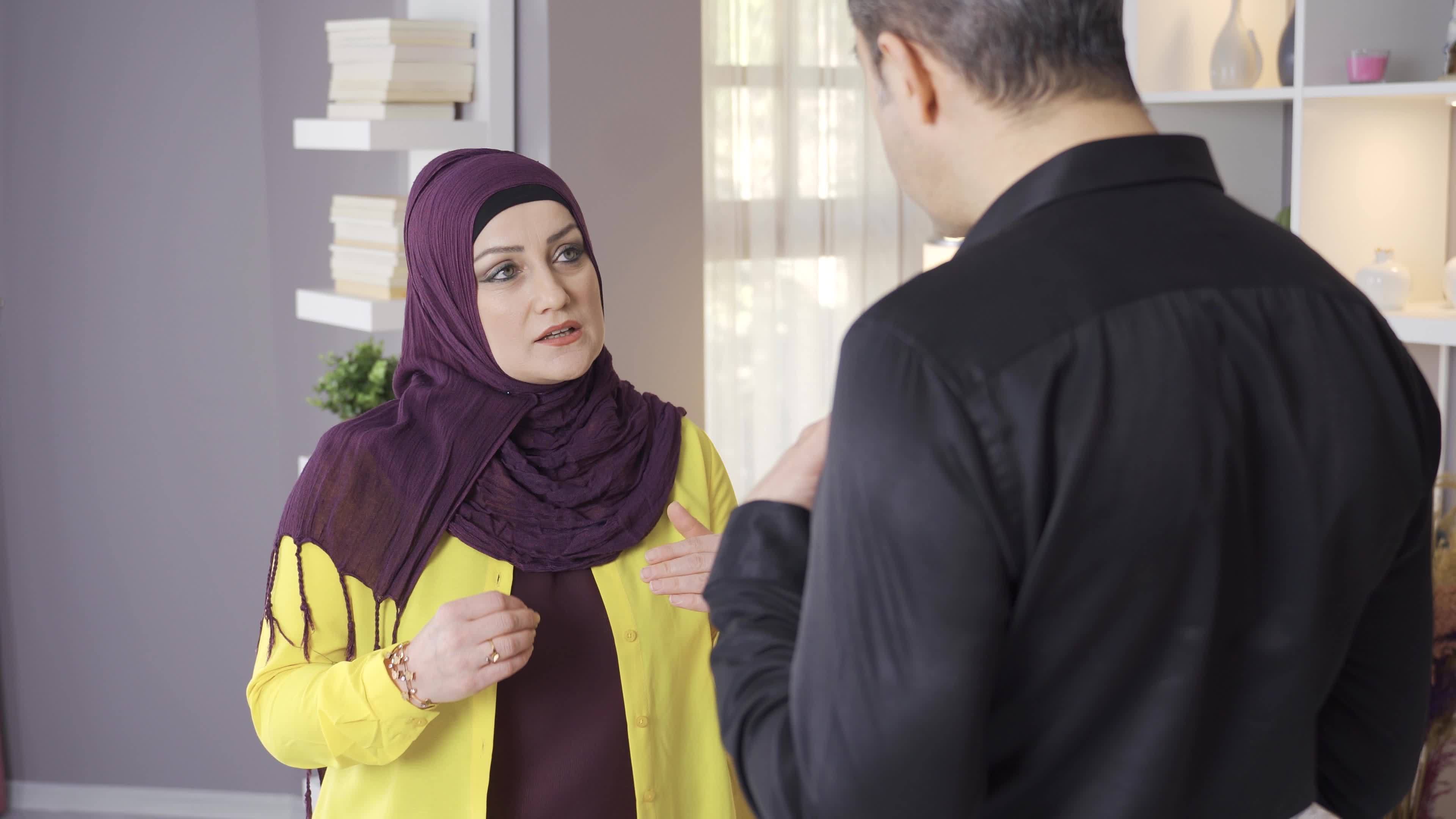 Family problems. Muslim husband and wife are arguing at home. Muslim ...