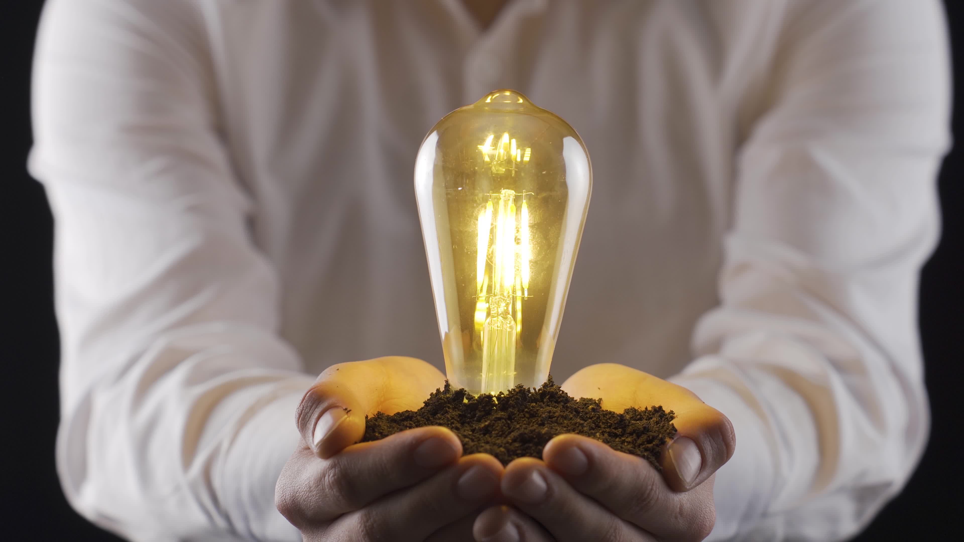 Idea sun. Male holding a grounded idea lamp. Smart man holding an idea light bulb. Eureka ...