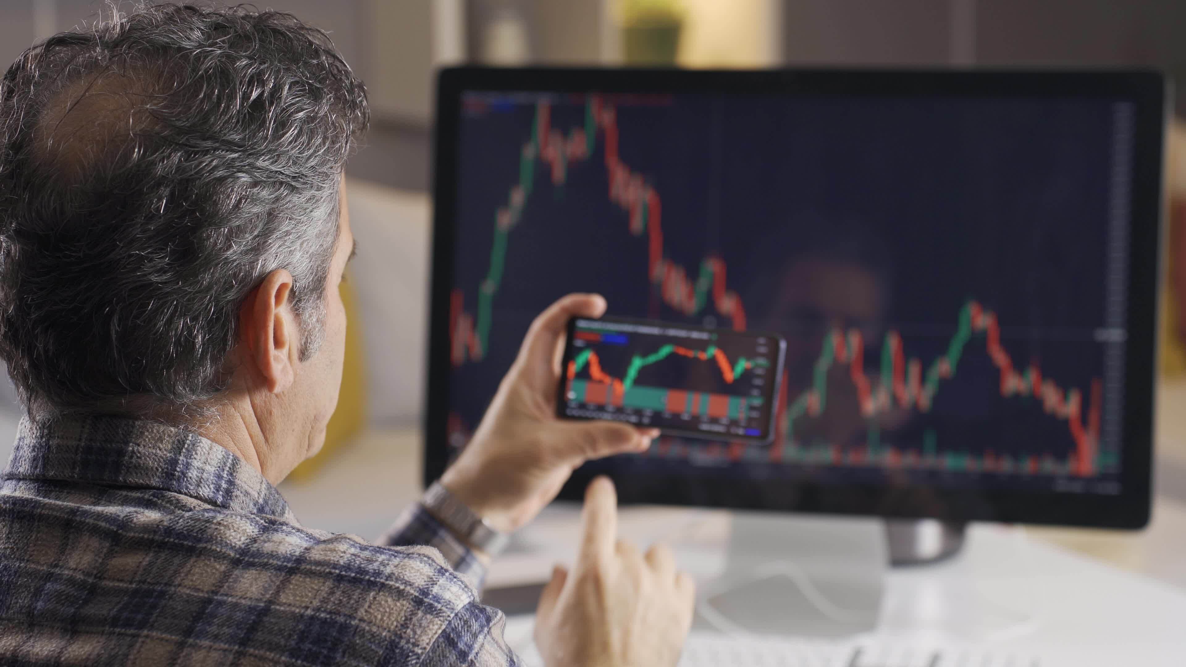 Man Searching And Analyzing Stock Market Data The Trader Looks And