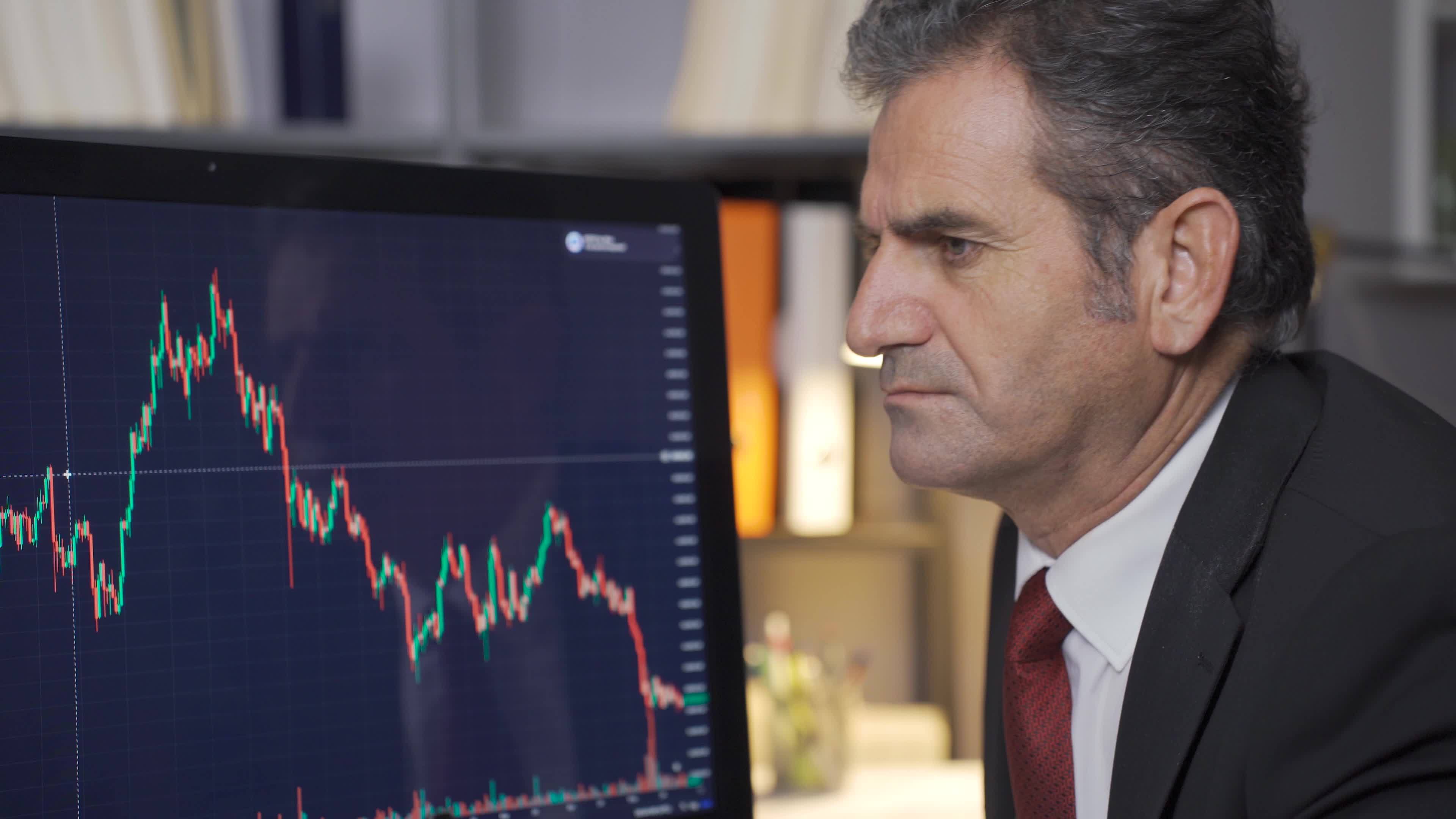 Mature Trader Man Analyzing A Stock Market And Cryptocurrency Chart