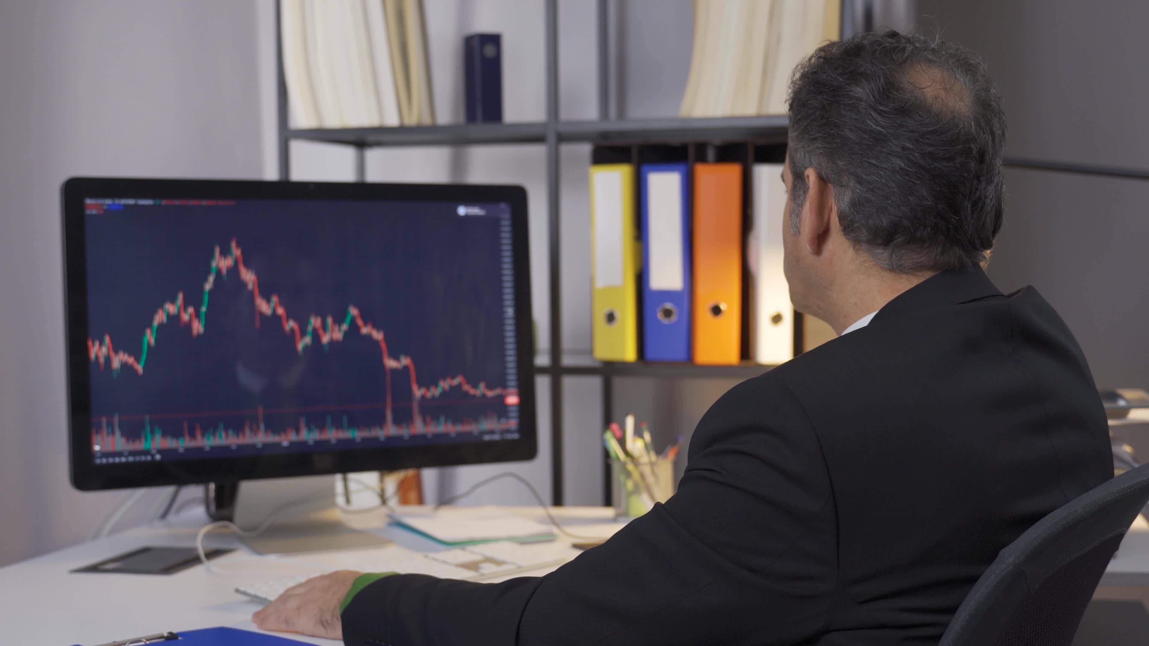 Businessman Monitors Stock Sales Statistics Investment Concept Office