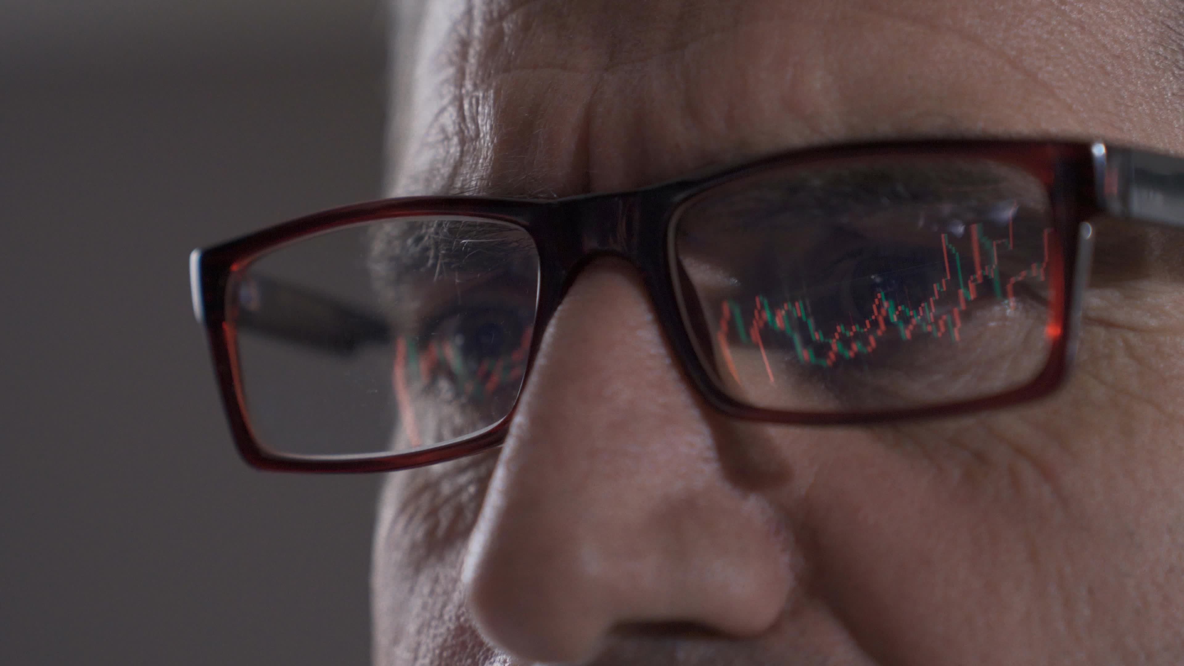Mature Trader Man Analyzing A Stock Market And Cryptocurrency Chart