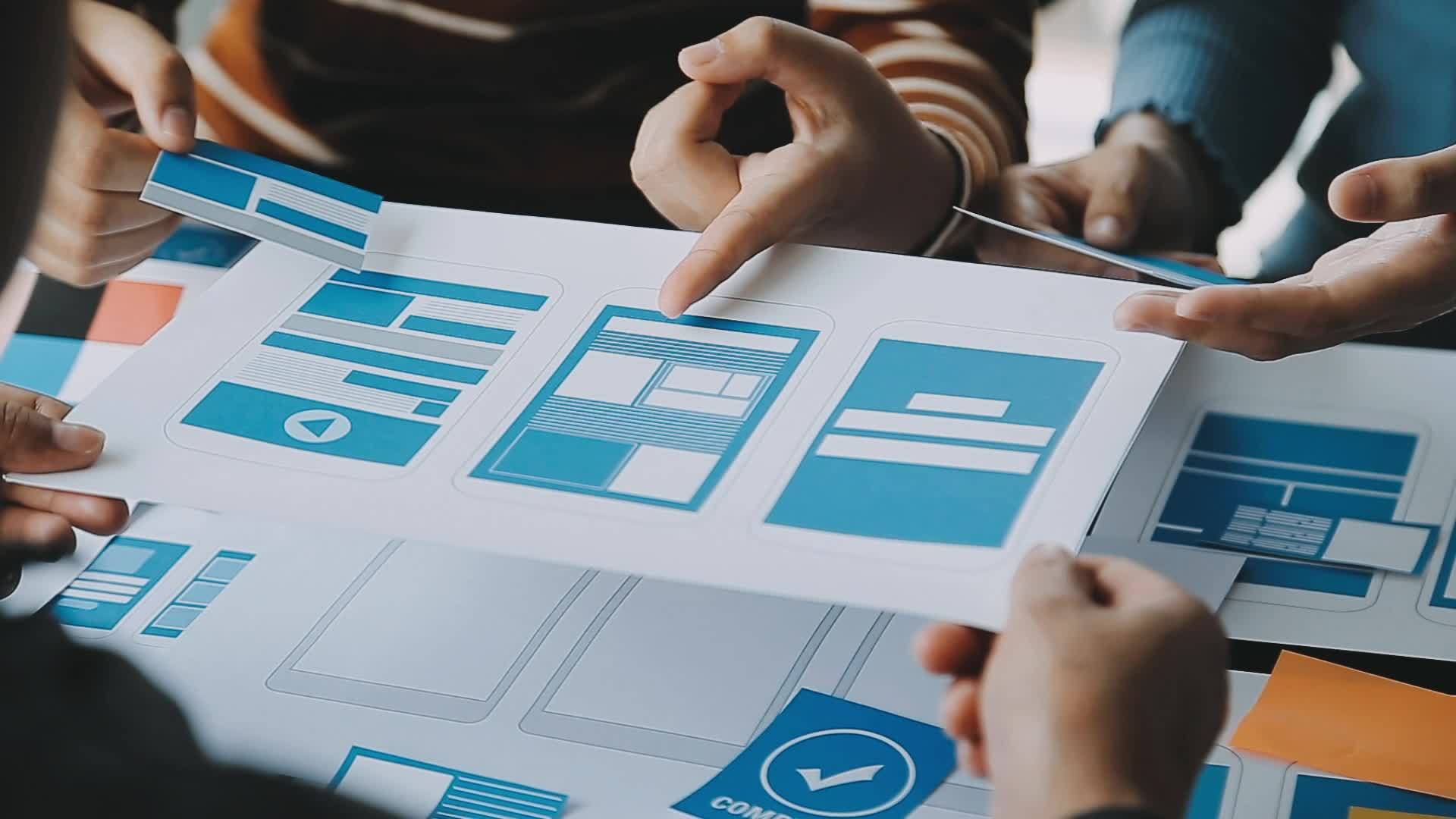 Close Up Ux Developer And Ui Designer Brainstorming About Mobile App Interface Wireframe Design