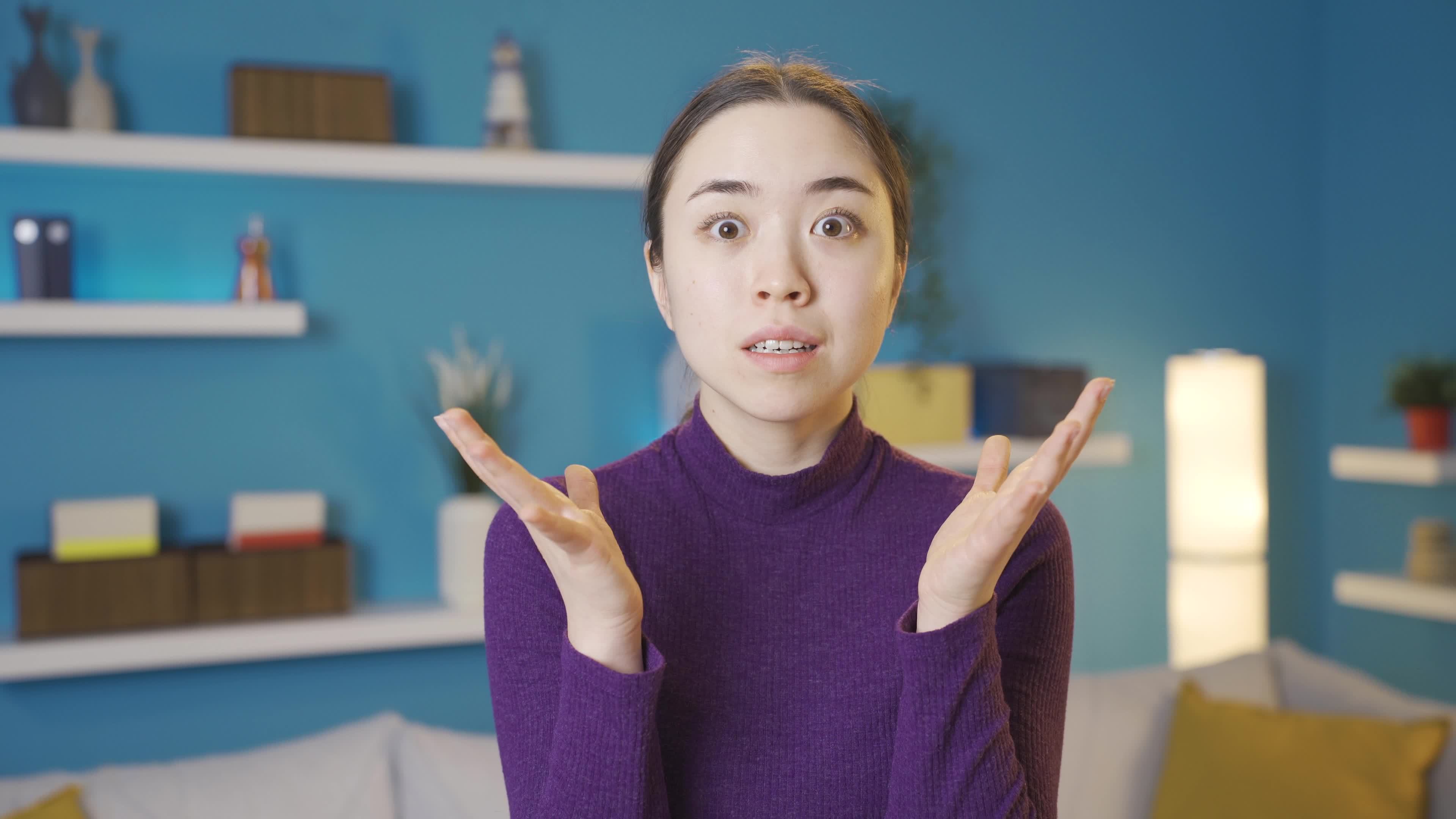 Asian young woman looking at camera confused. Asian woman making ...