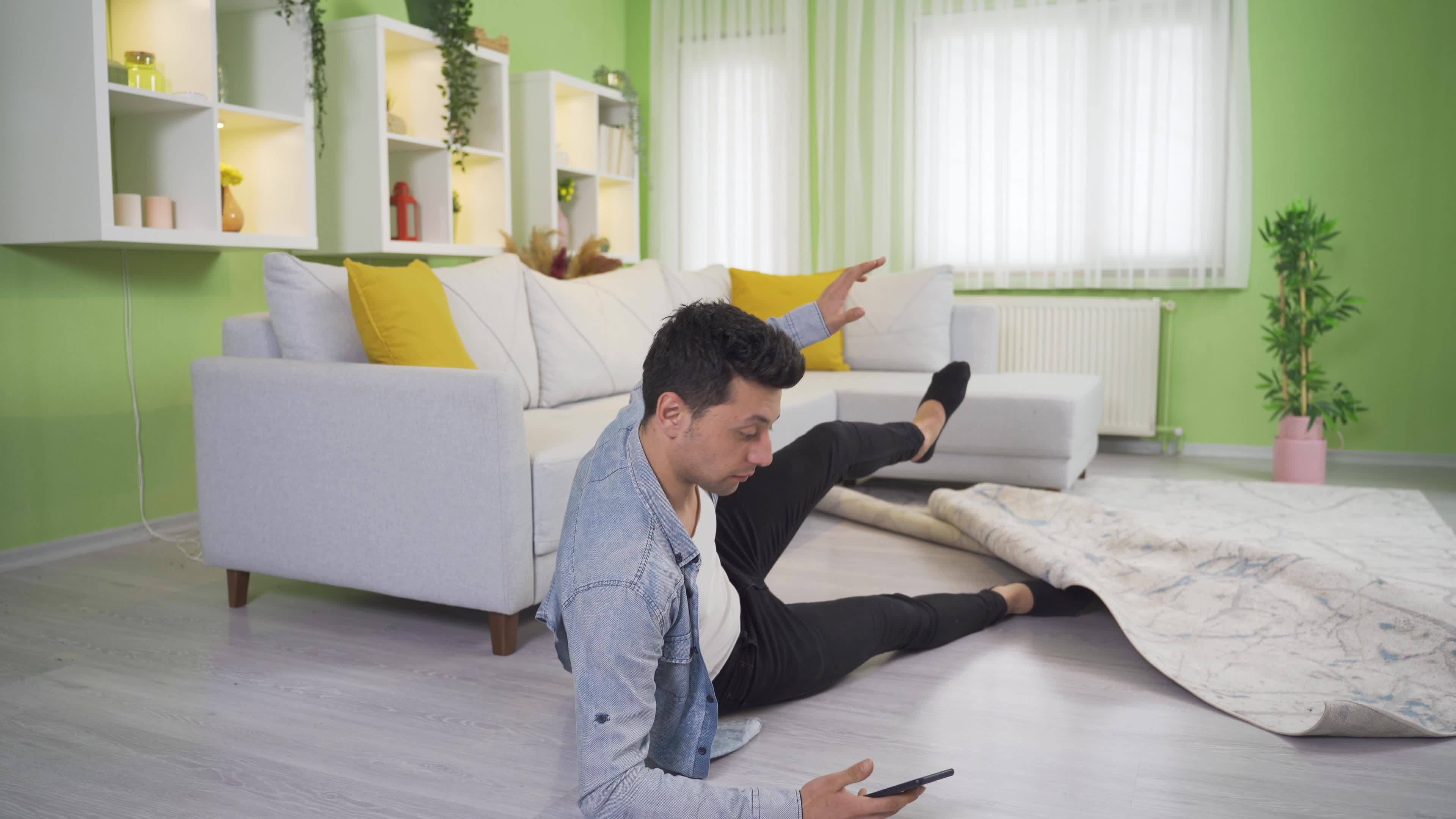 Unfortunate Clumsy Young Man Slips And Falls While Walking At Home The