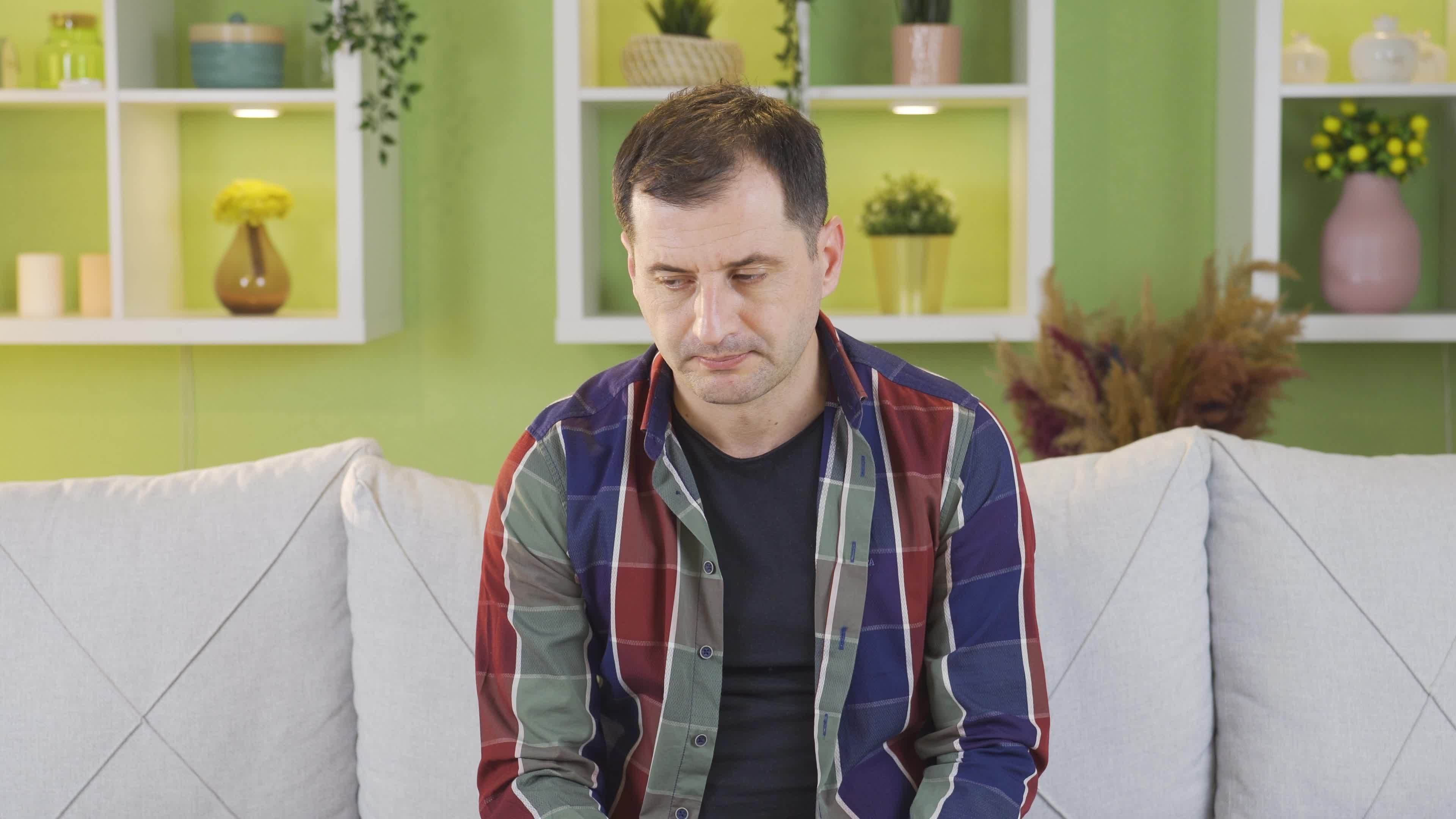 Man looking around with unhappy and disappointed eyes. The man sitting ...