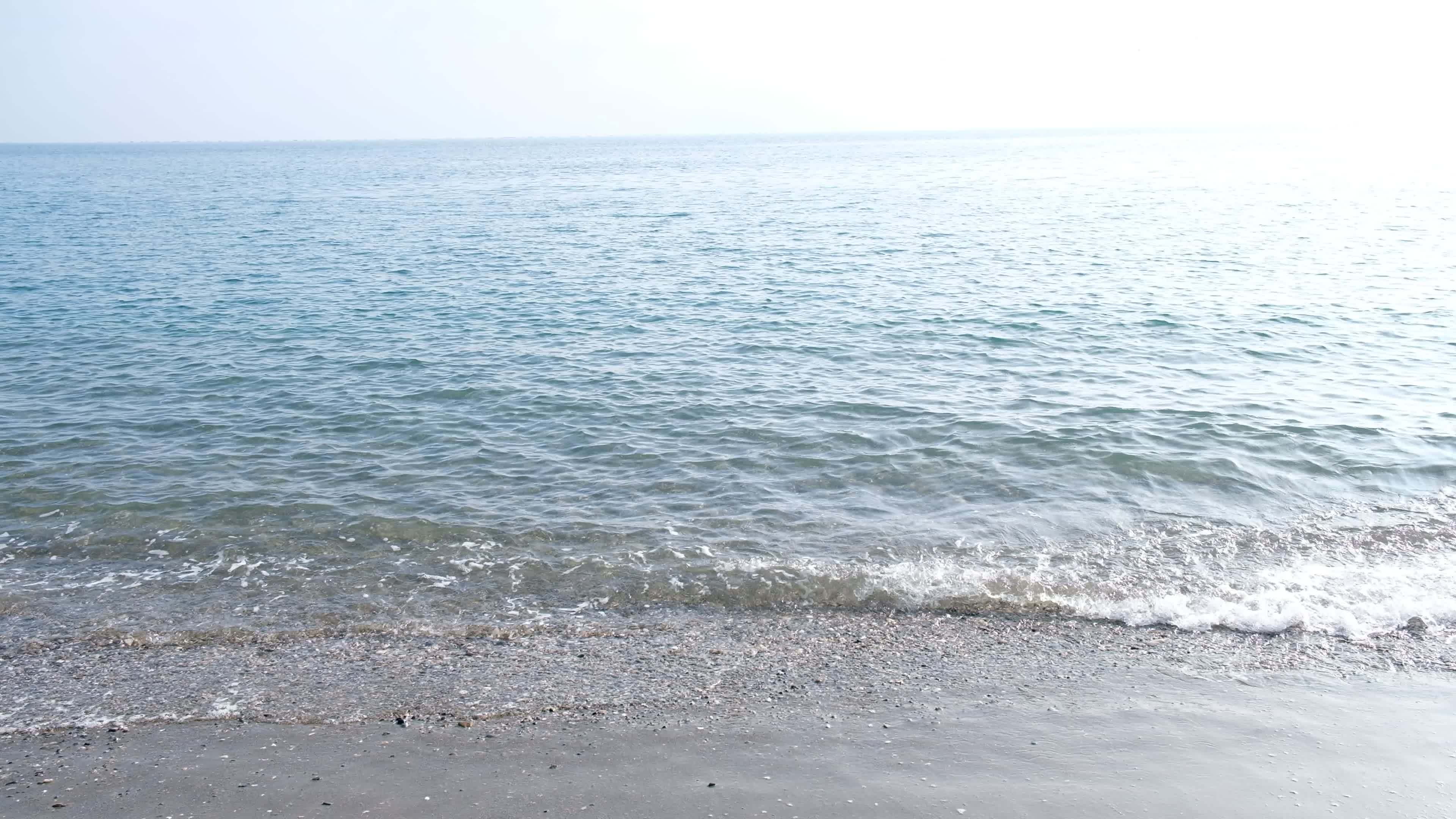 Waves of Sea rolling to sandy beach. Blur high wave. Close-up shot of ...
