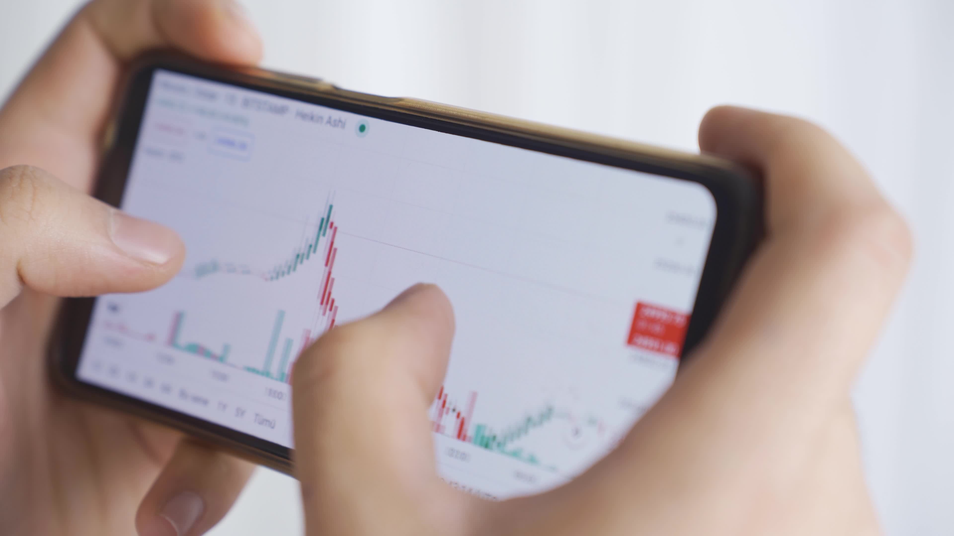 Close Up Of Man Looking At Stock Market Stock Investment Charts On